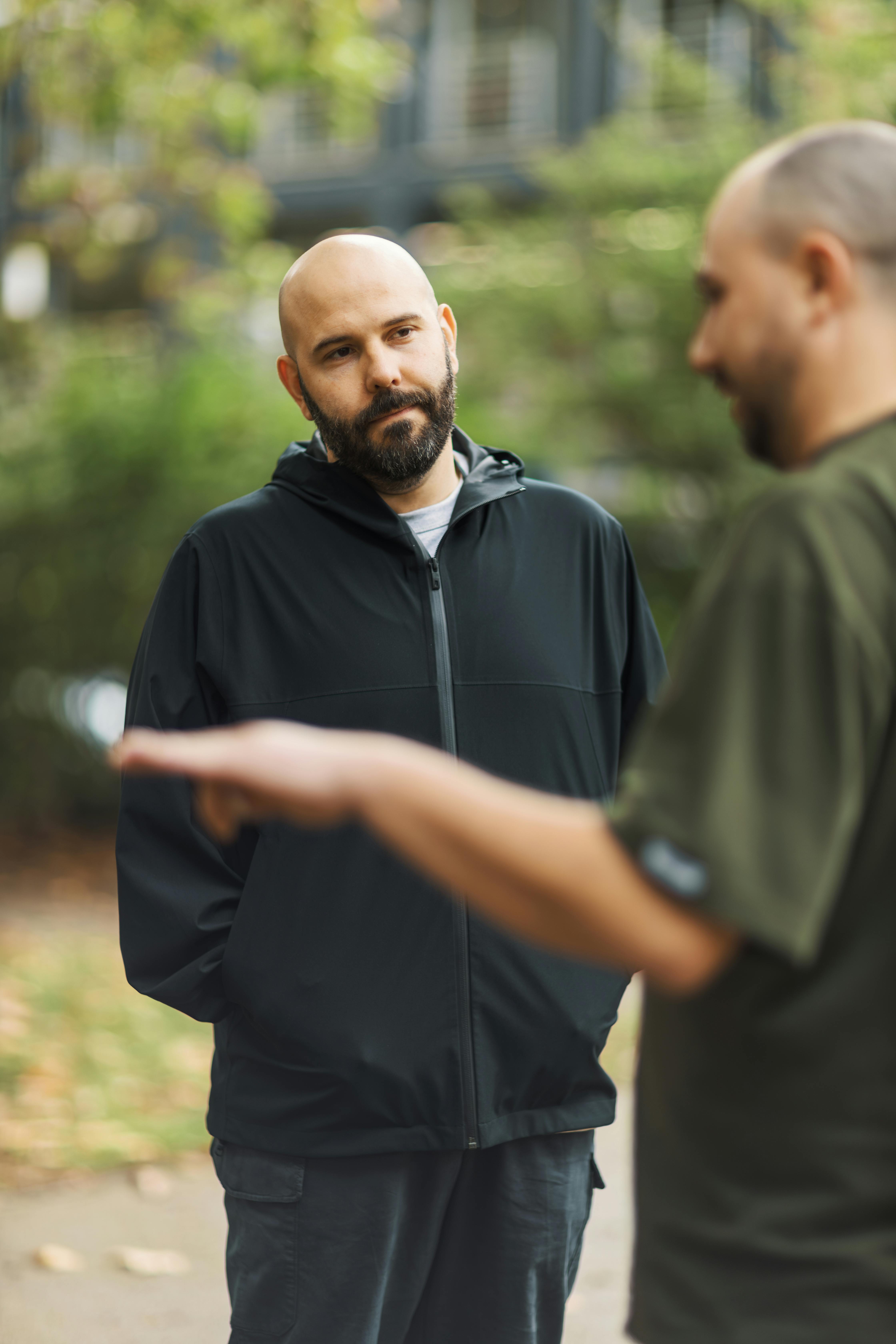 Casual Outdoor Conversation Between Men · Free Stock Photo
