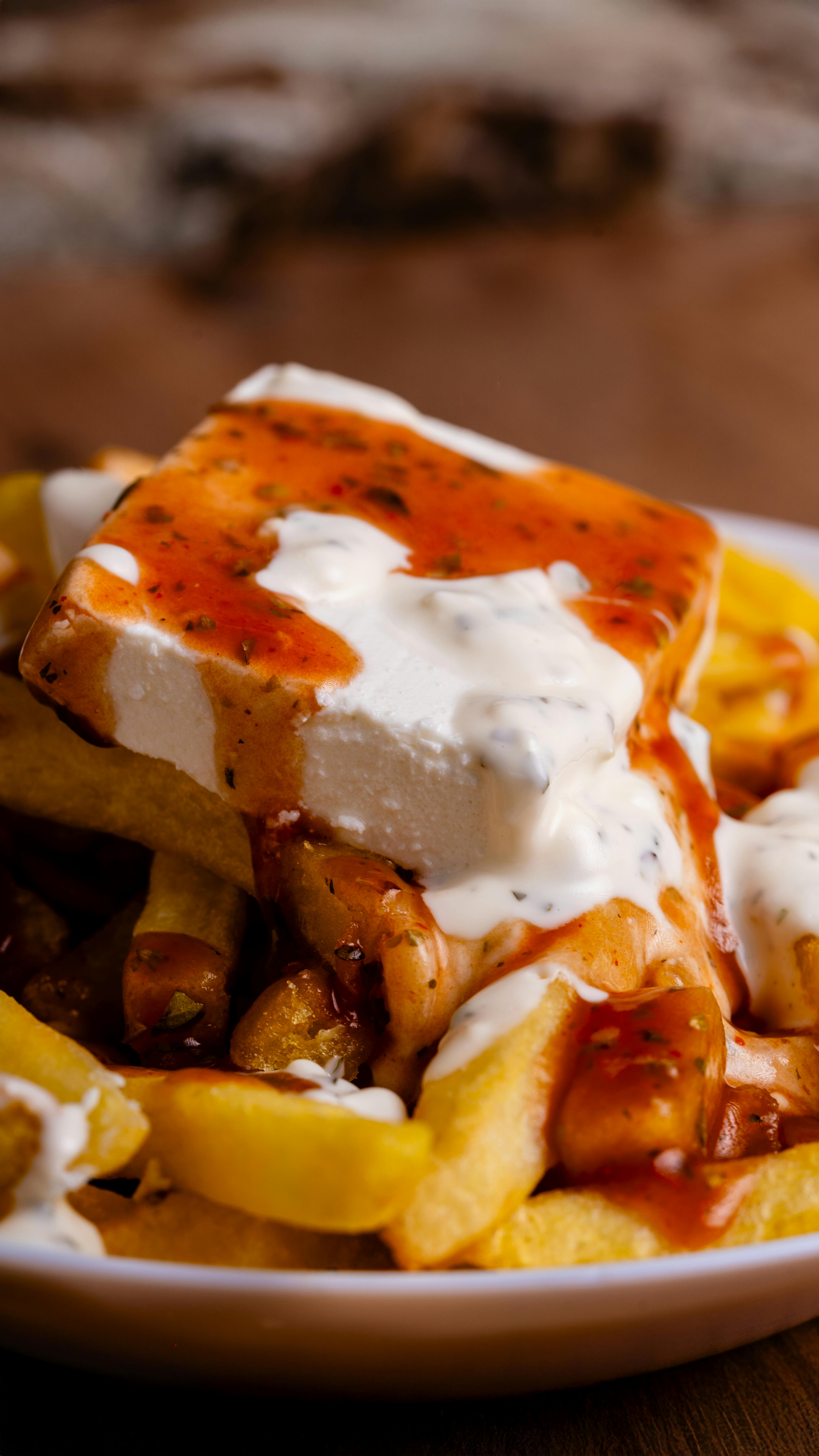 Delicious Loaded Fries with Saucy Cheese Topping · Free Stock Photo