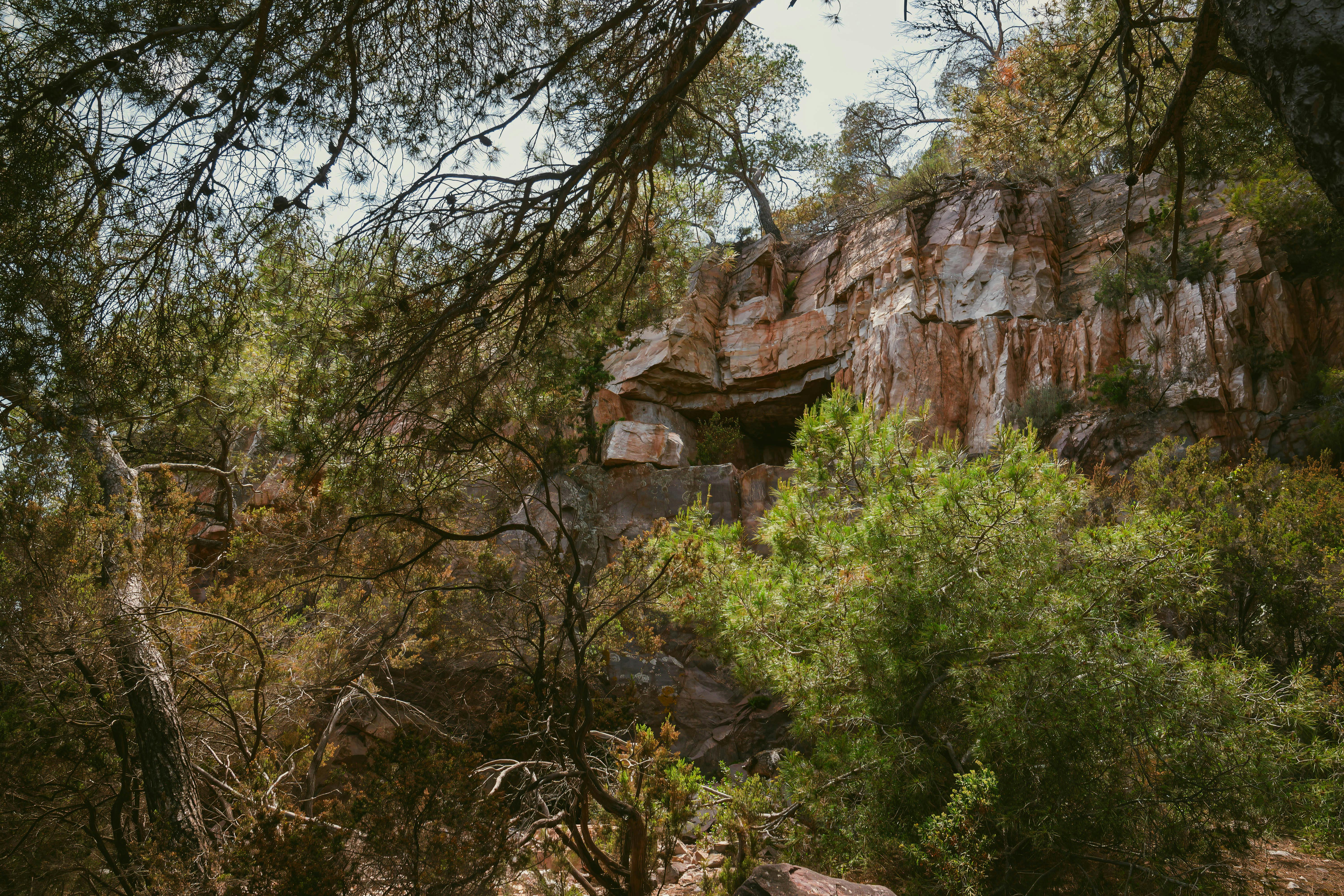 Gray Cave Near Body of Water · Free Stock Photo