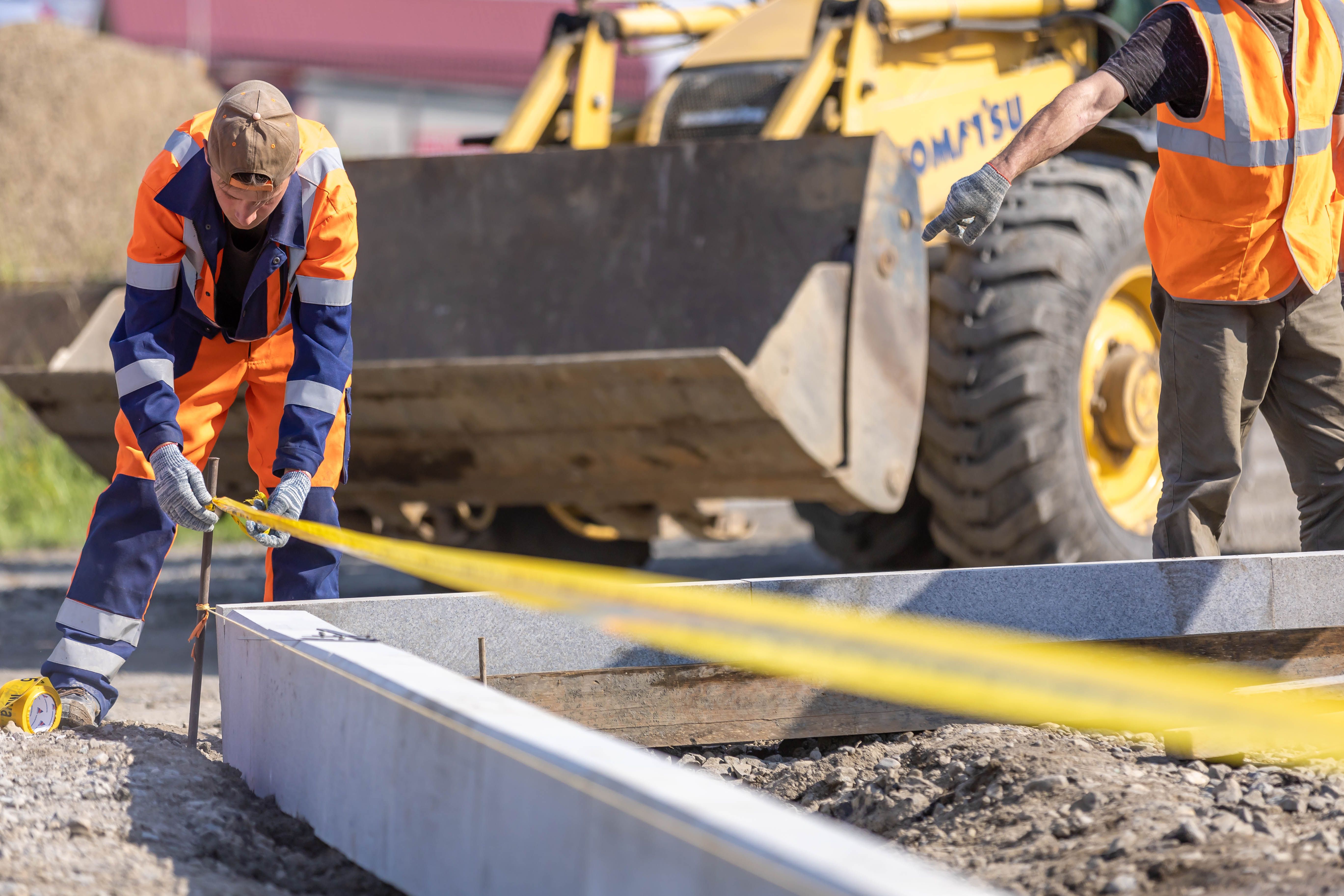 Construction workers measuring at job site outdoors · Free Stock Photo