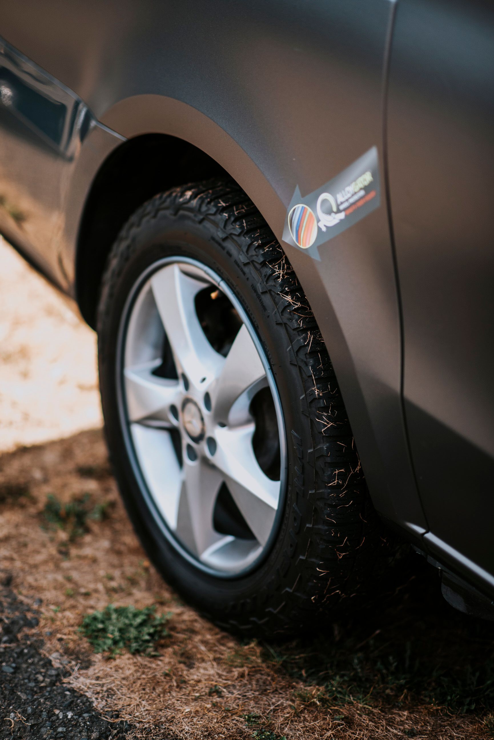 Close-Up of Automobile Rear Wheel and Tire Outdoors · Free Stock Photo
