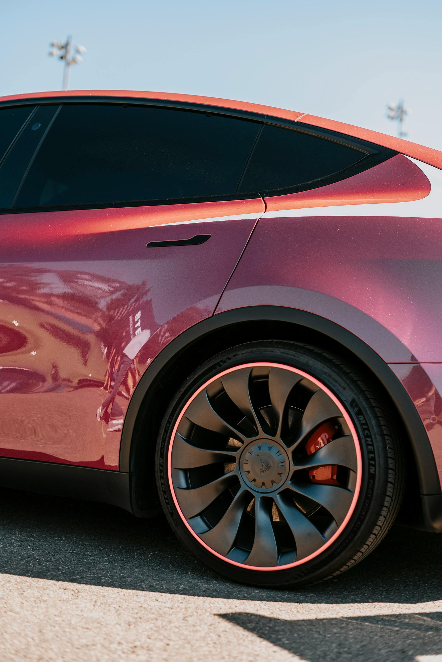 Close-up of a Stylish Red Car Wheel Outdoors · Free Stock Photo