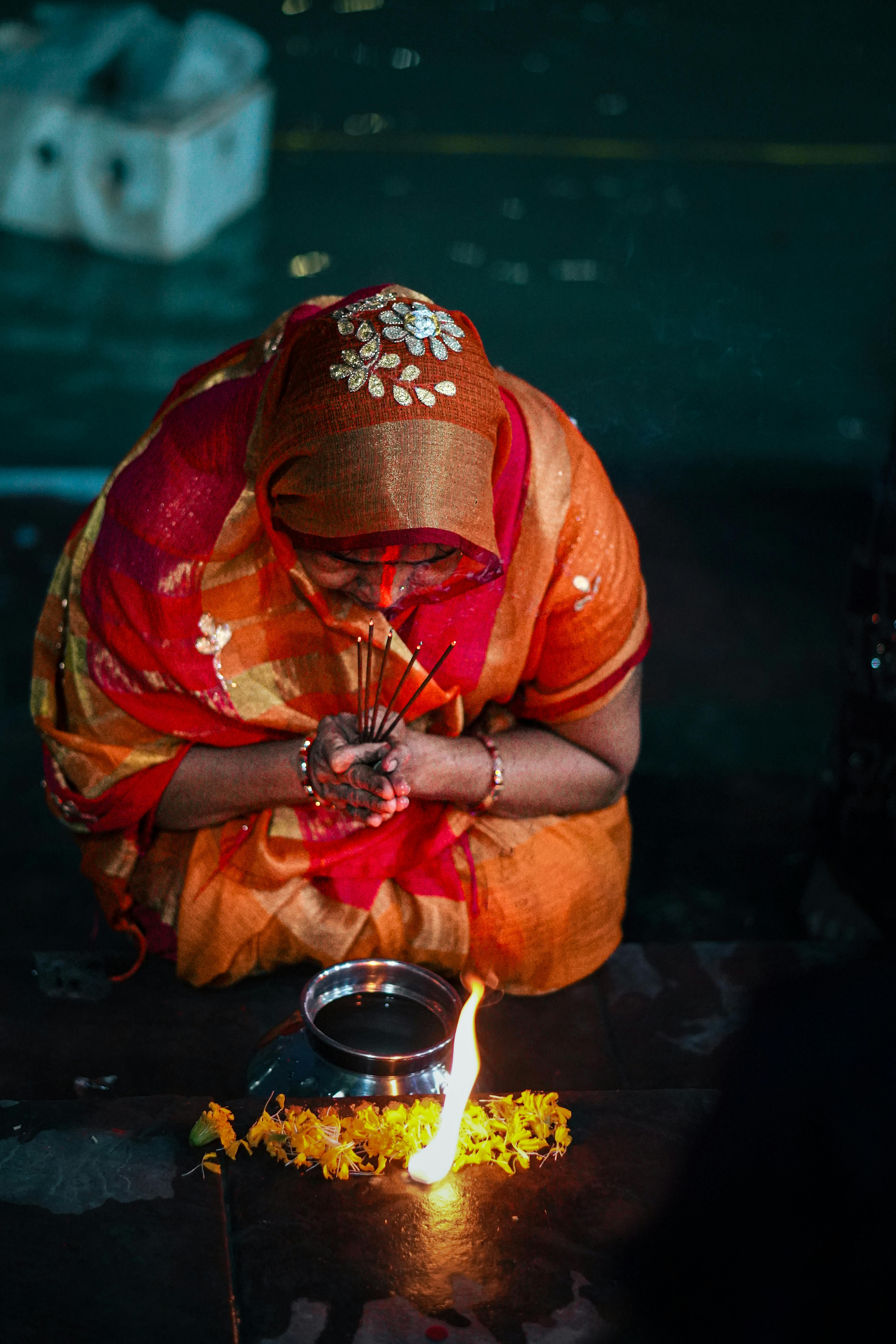 Woman in Traditional Attire Performing Ritual · Free Stock Photo