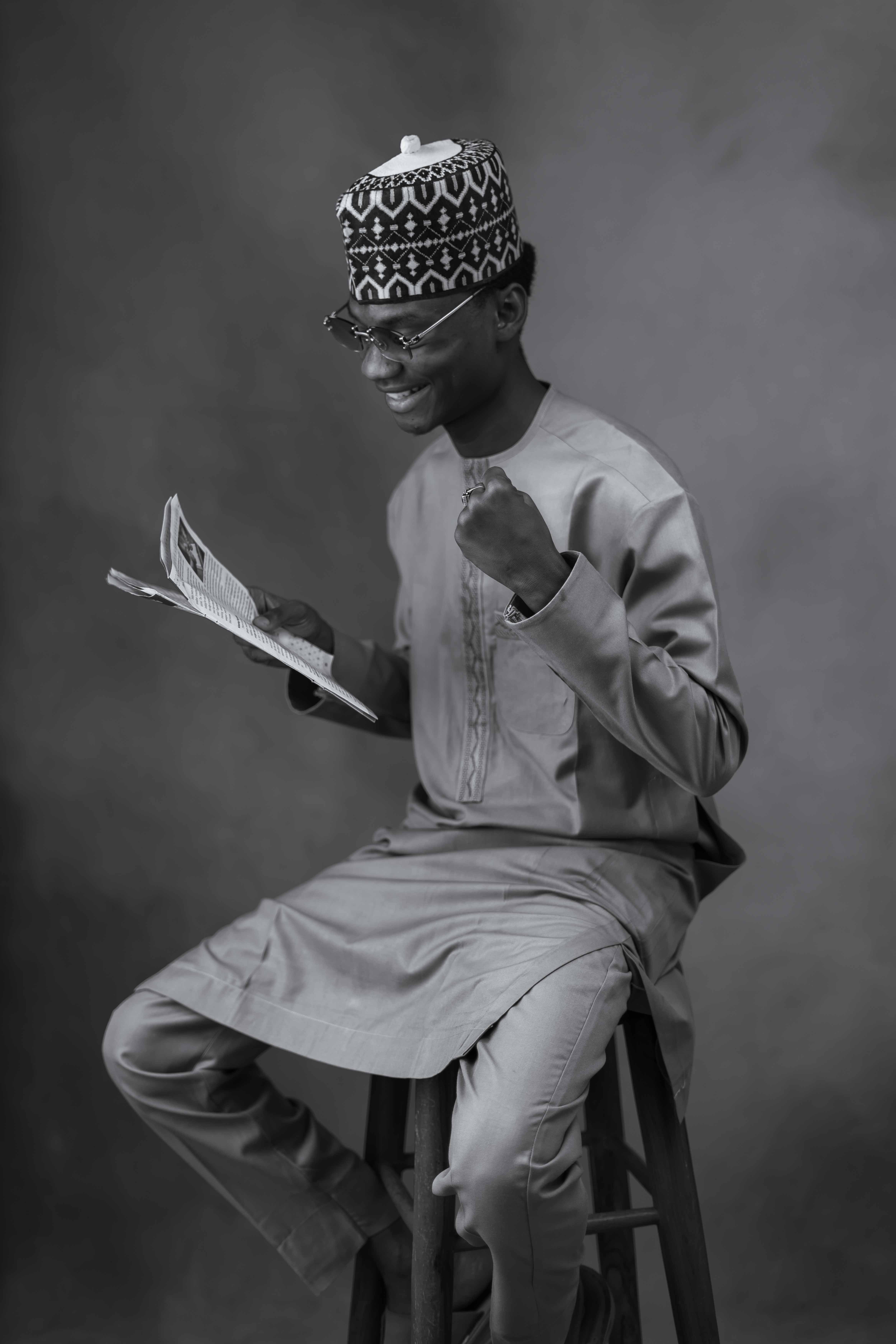 Nigerian Man Reading in Traditional Attire · Free Stock Photo