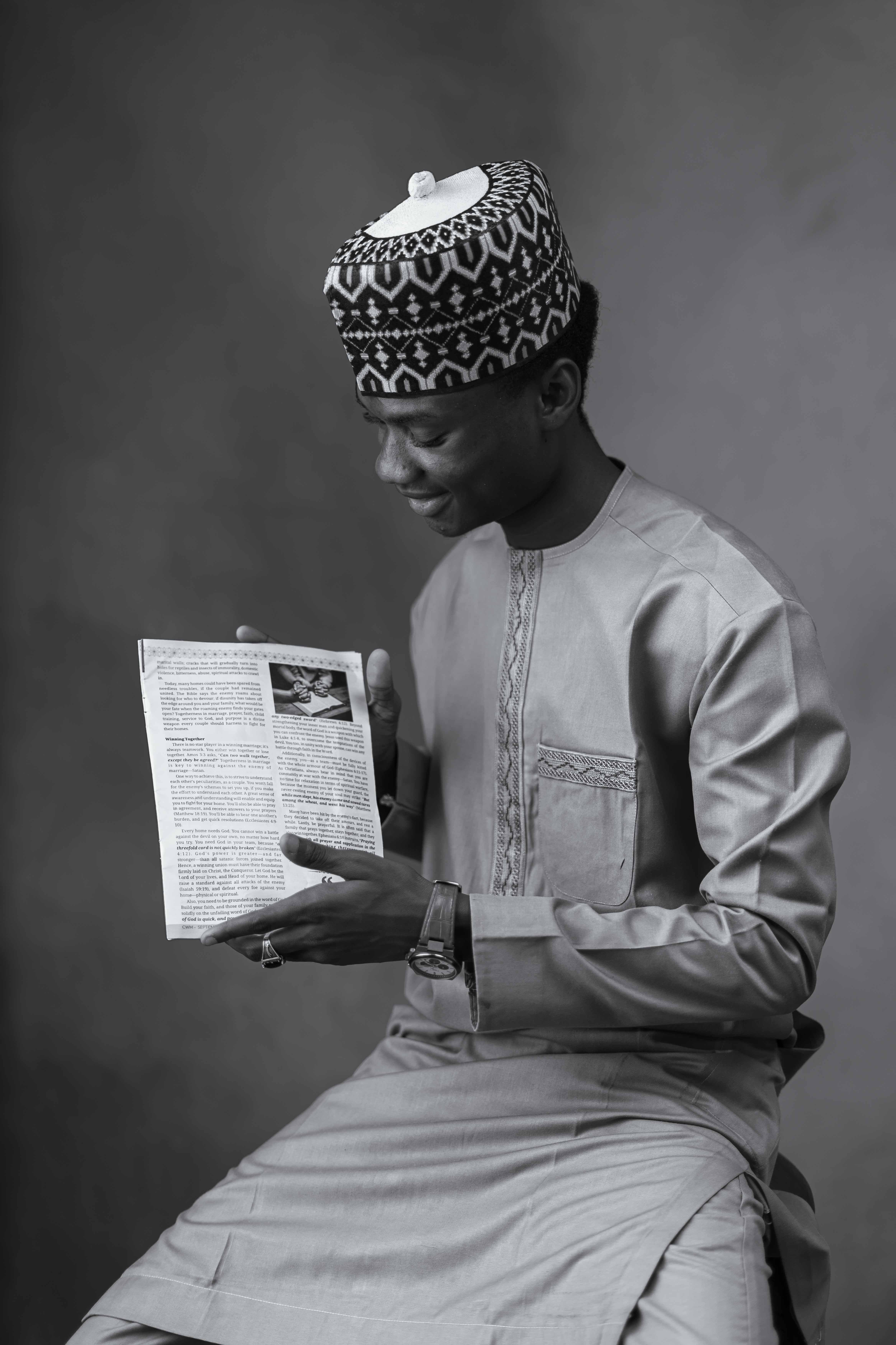 Nigerian Man Reading in Traditional Attire · Free Stock Photo