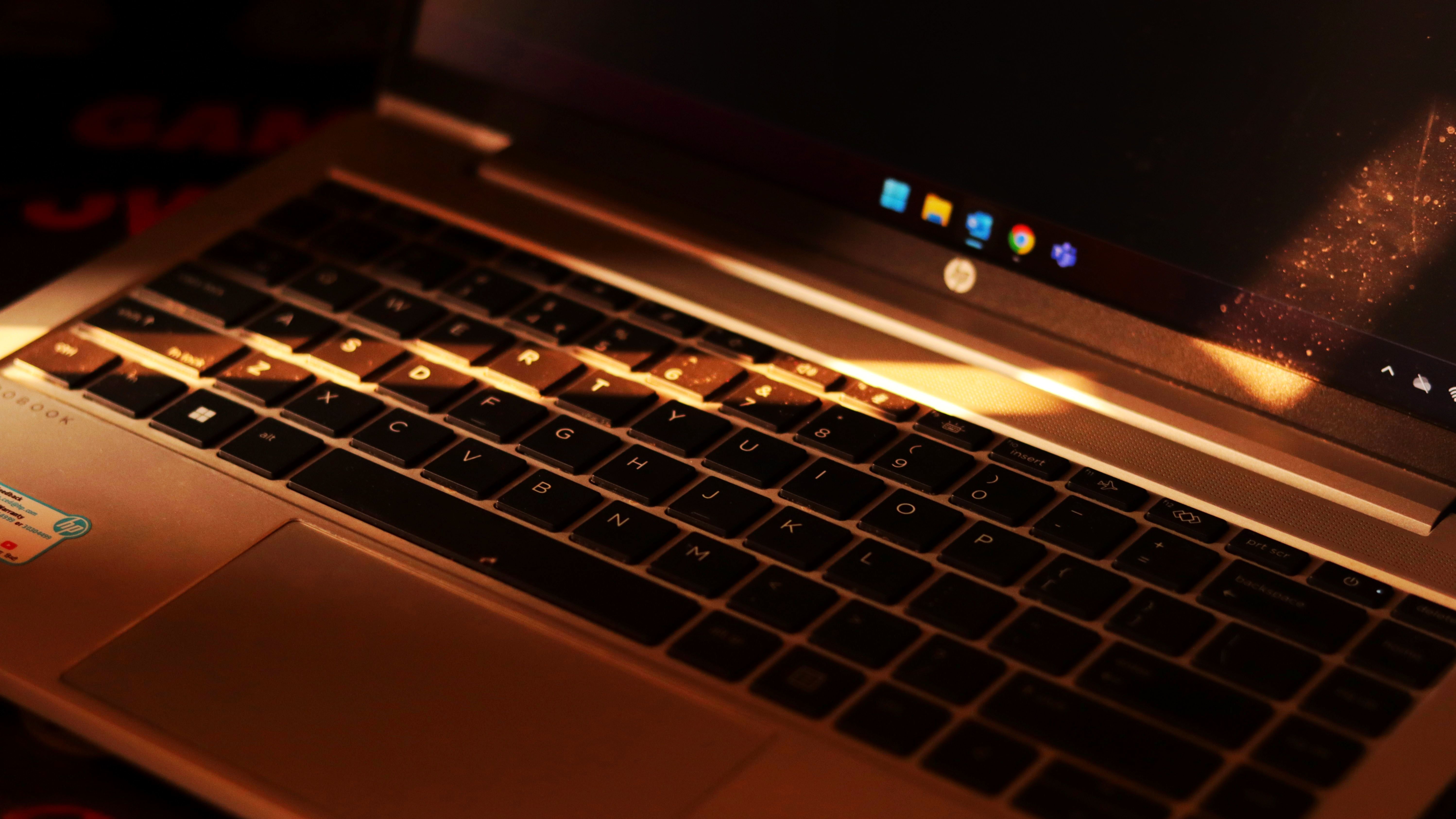 Warm Sunlight on Laptop Keyboard · Free Stock Photo