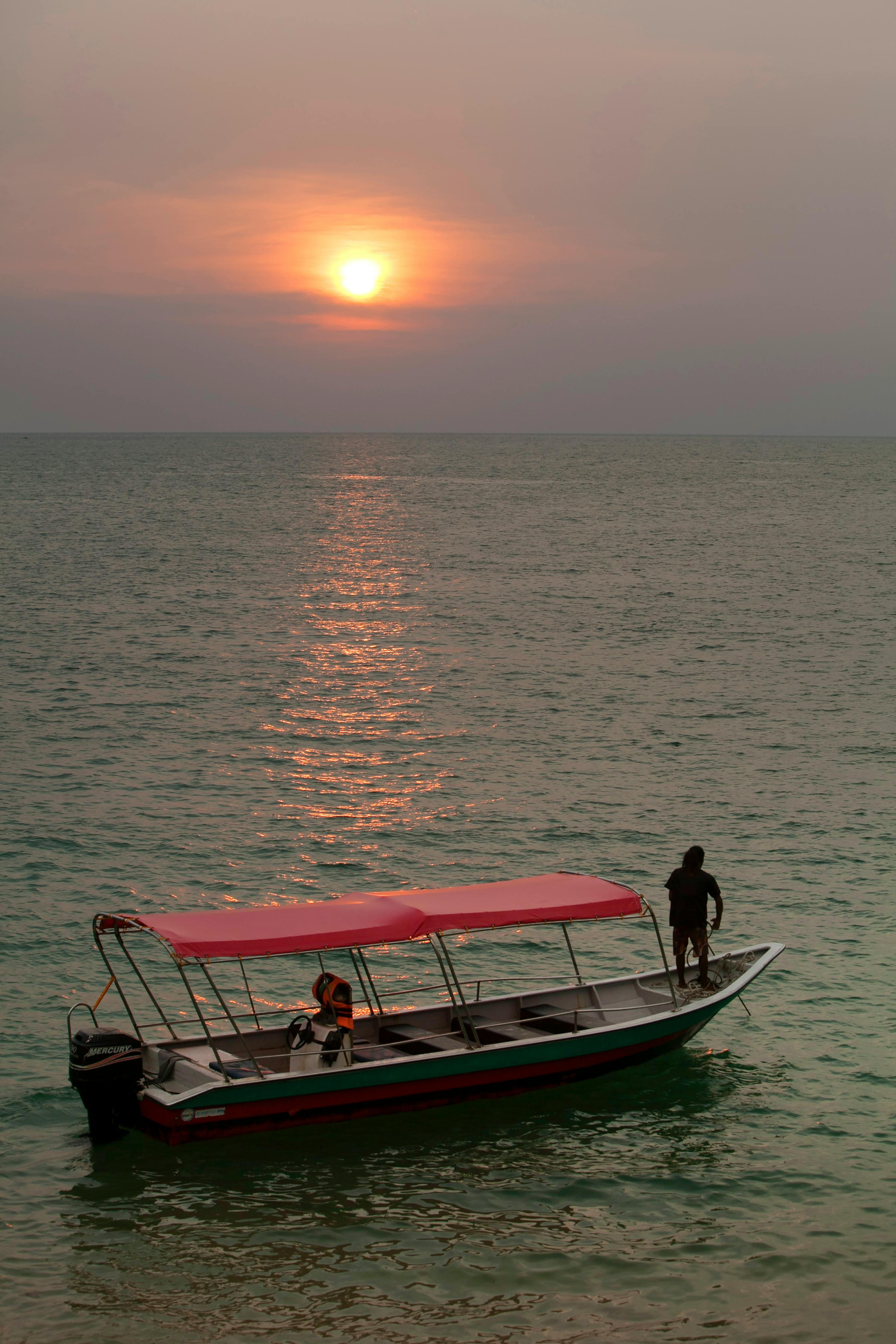 Sunset View Over Ocean with Boat · Free Stock Photo