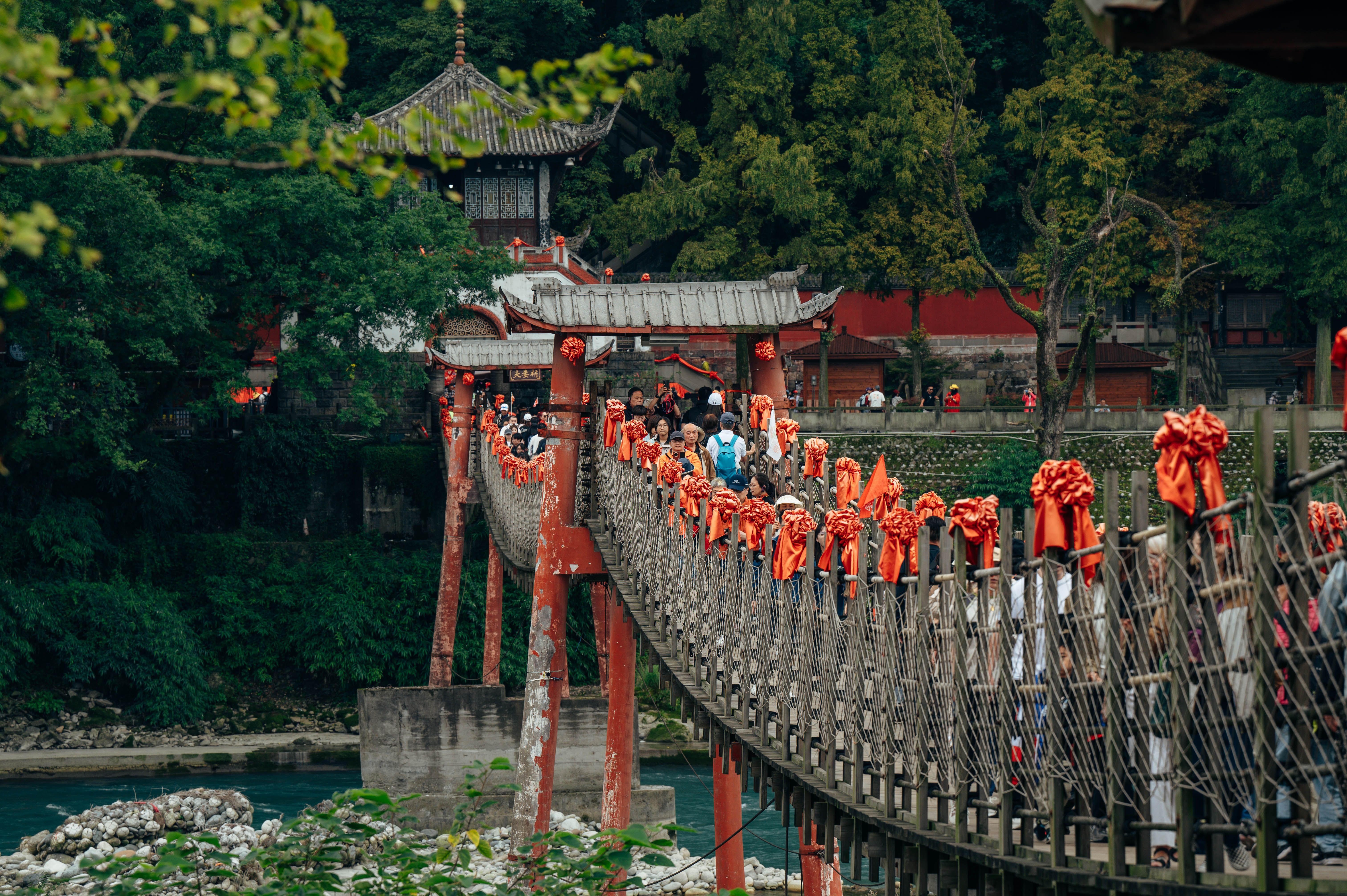 Vibrant Orange-Ribboned Asian Suspension Bridge · Free Stock Photo
