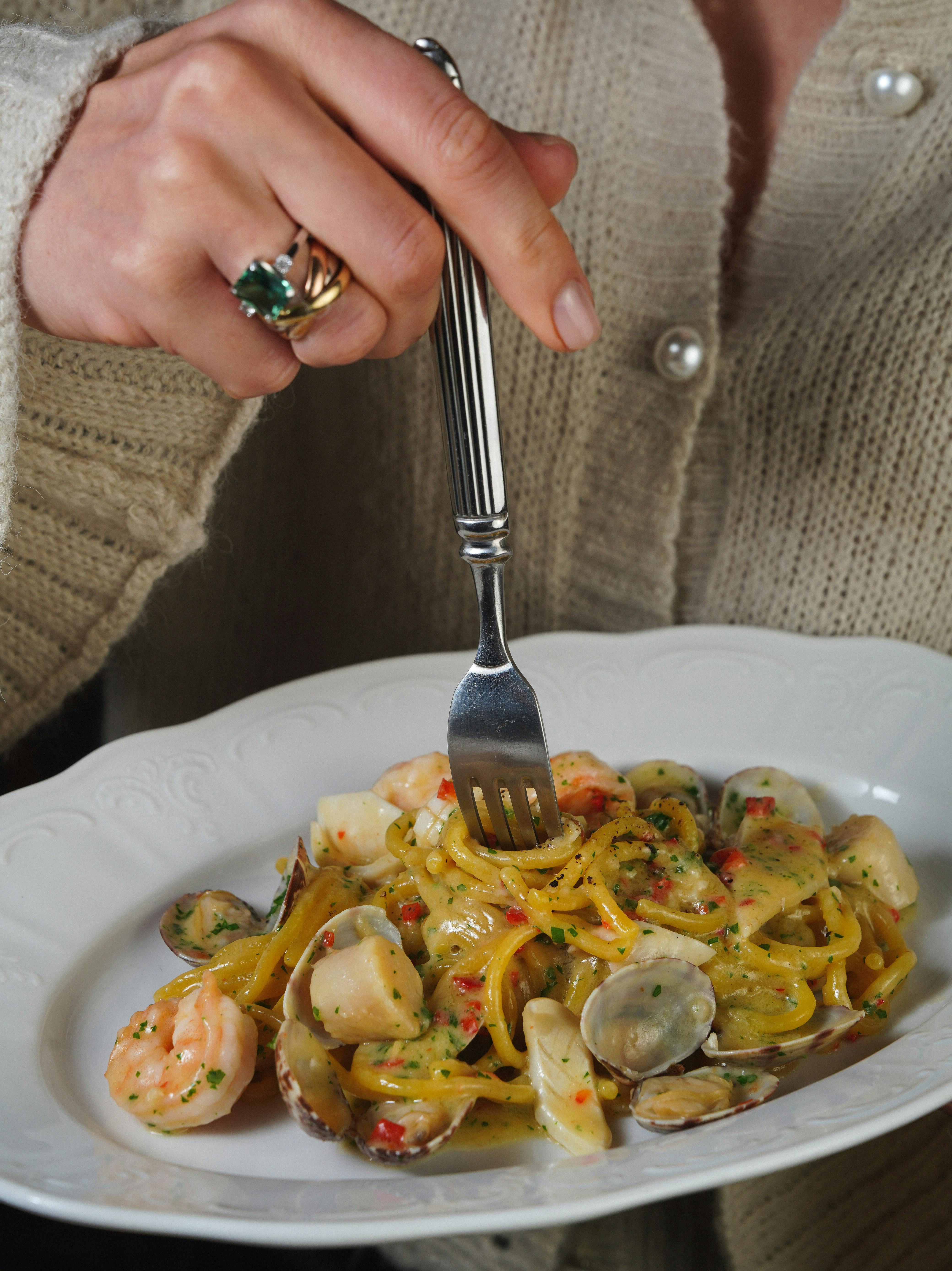 Seafood Pasta Dish with Elegant Dining Setting · Free Stock Photo