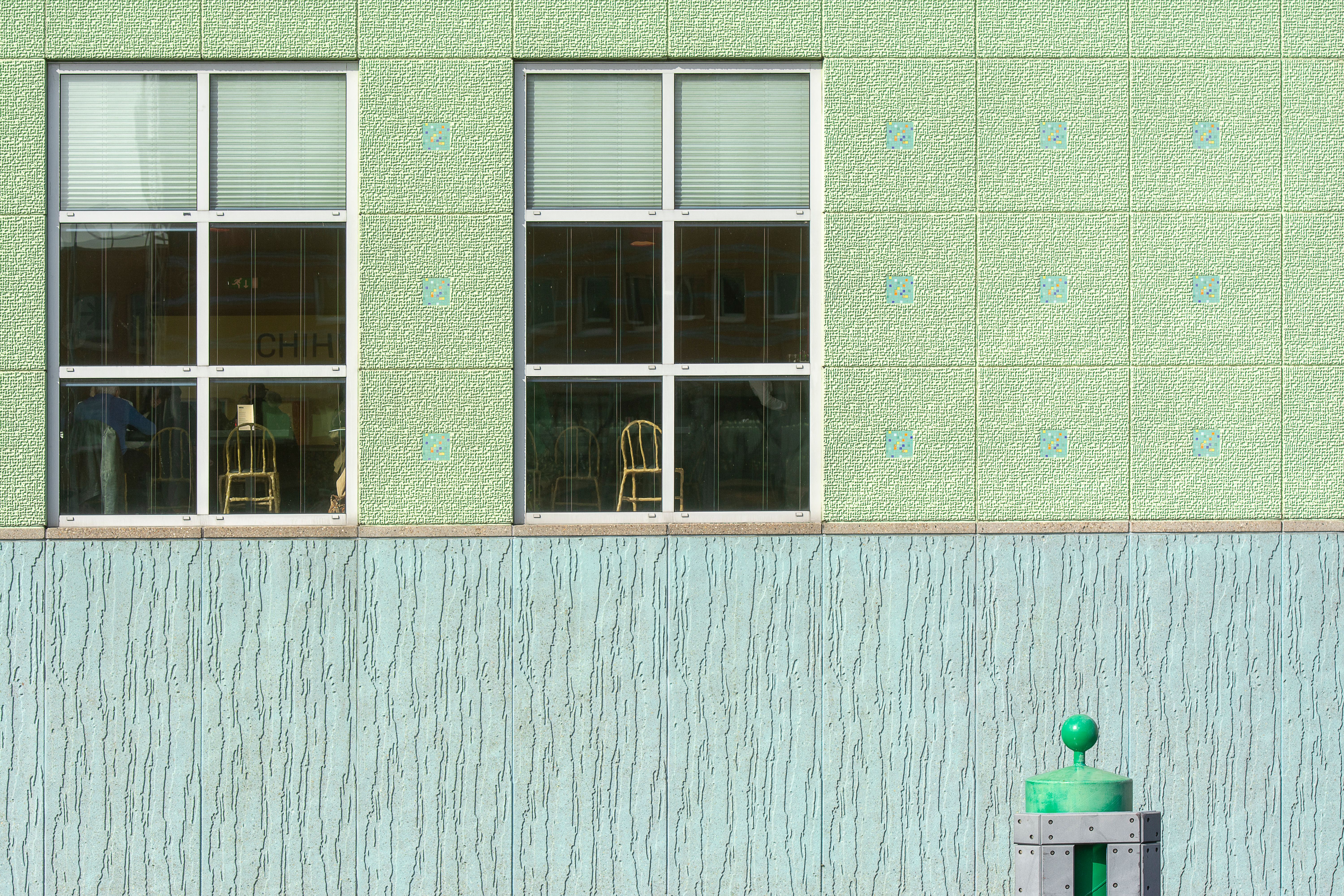 Modern Green Building Exterior with Large Windows · Free Stock Photo