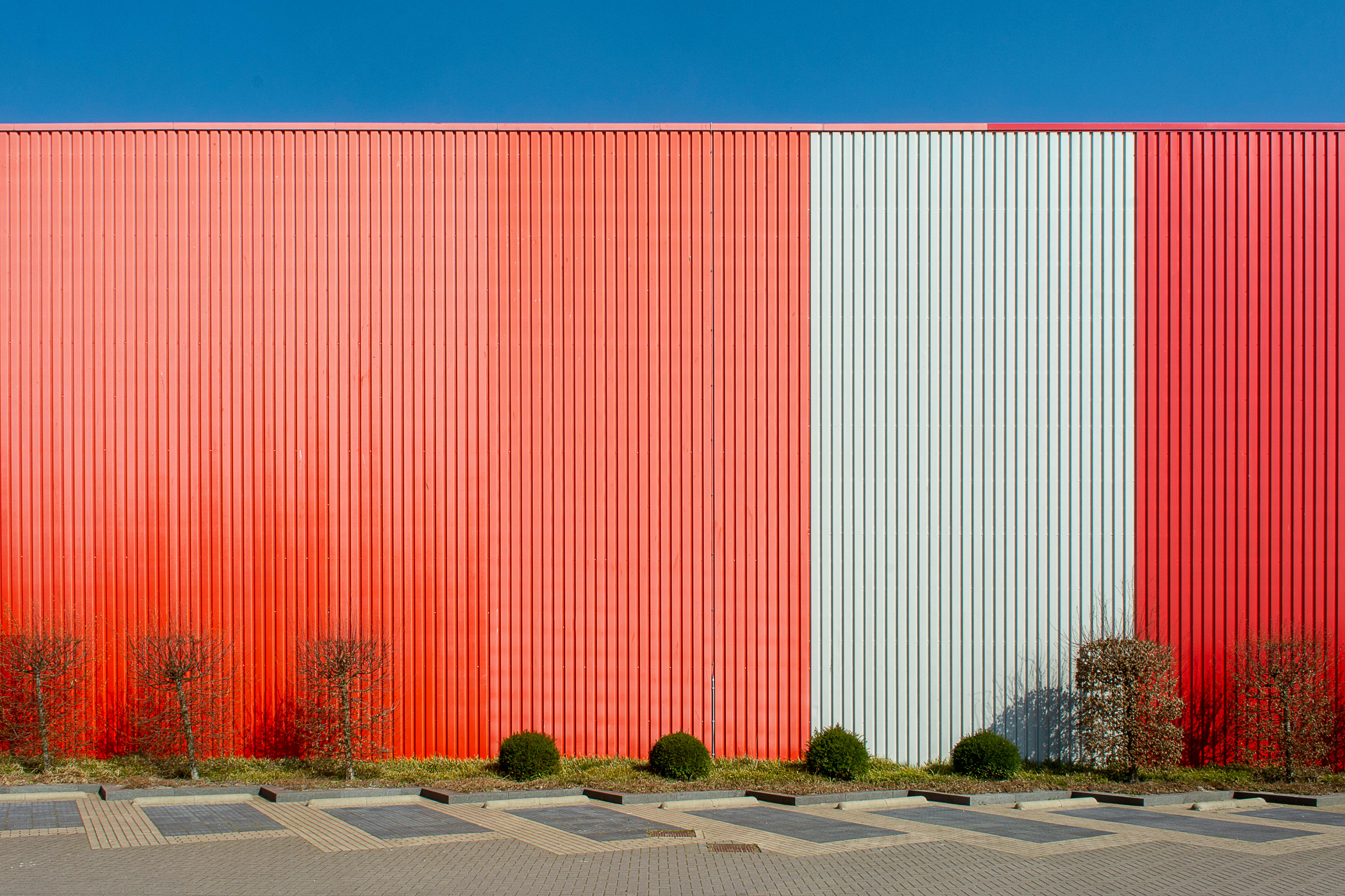 Colorful Industrial Building Exterior with Red Panels · Free Stock Photo
