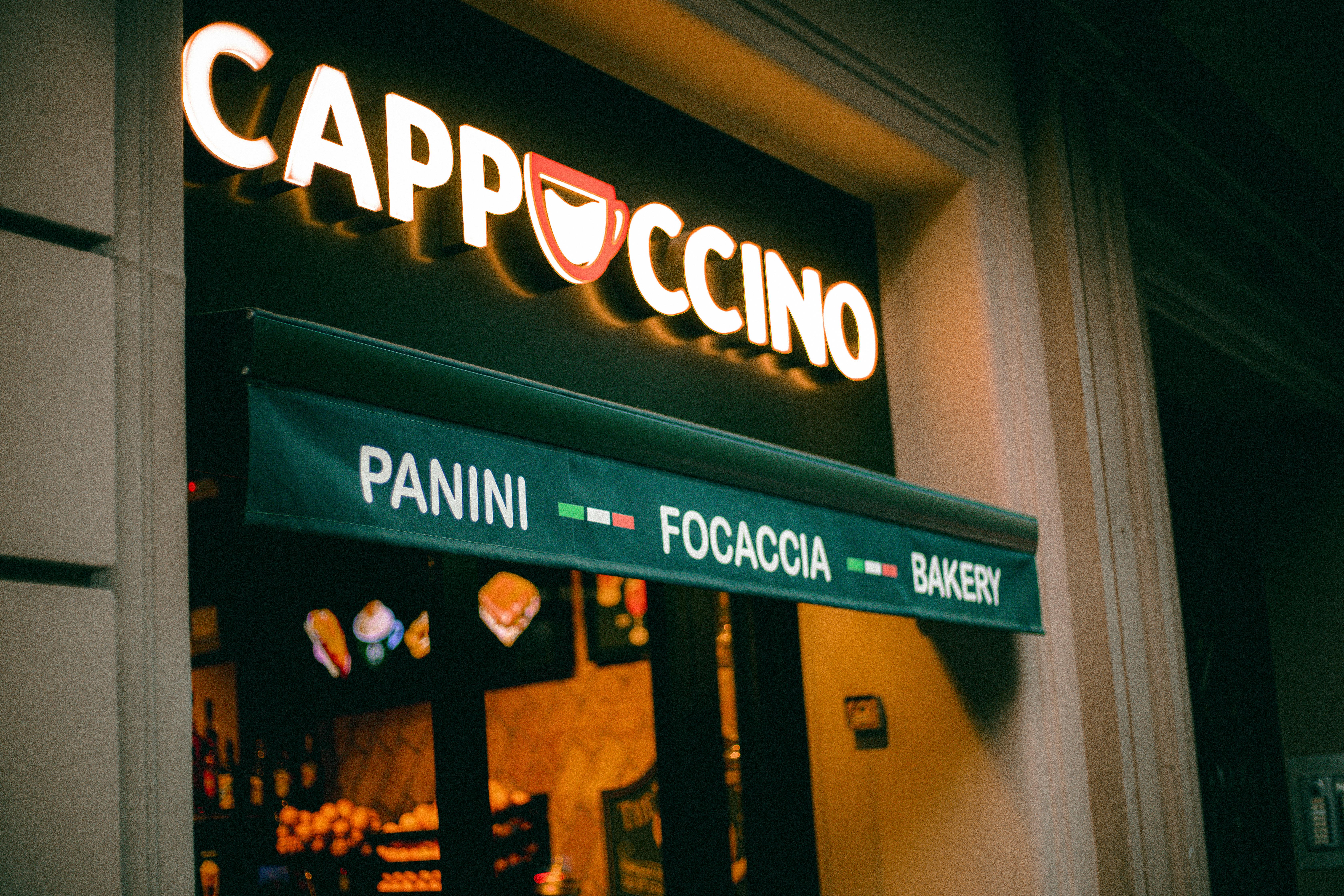 Cozy Italian Cafe Exterior Sign with Menu Awning · Free Stock Photo