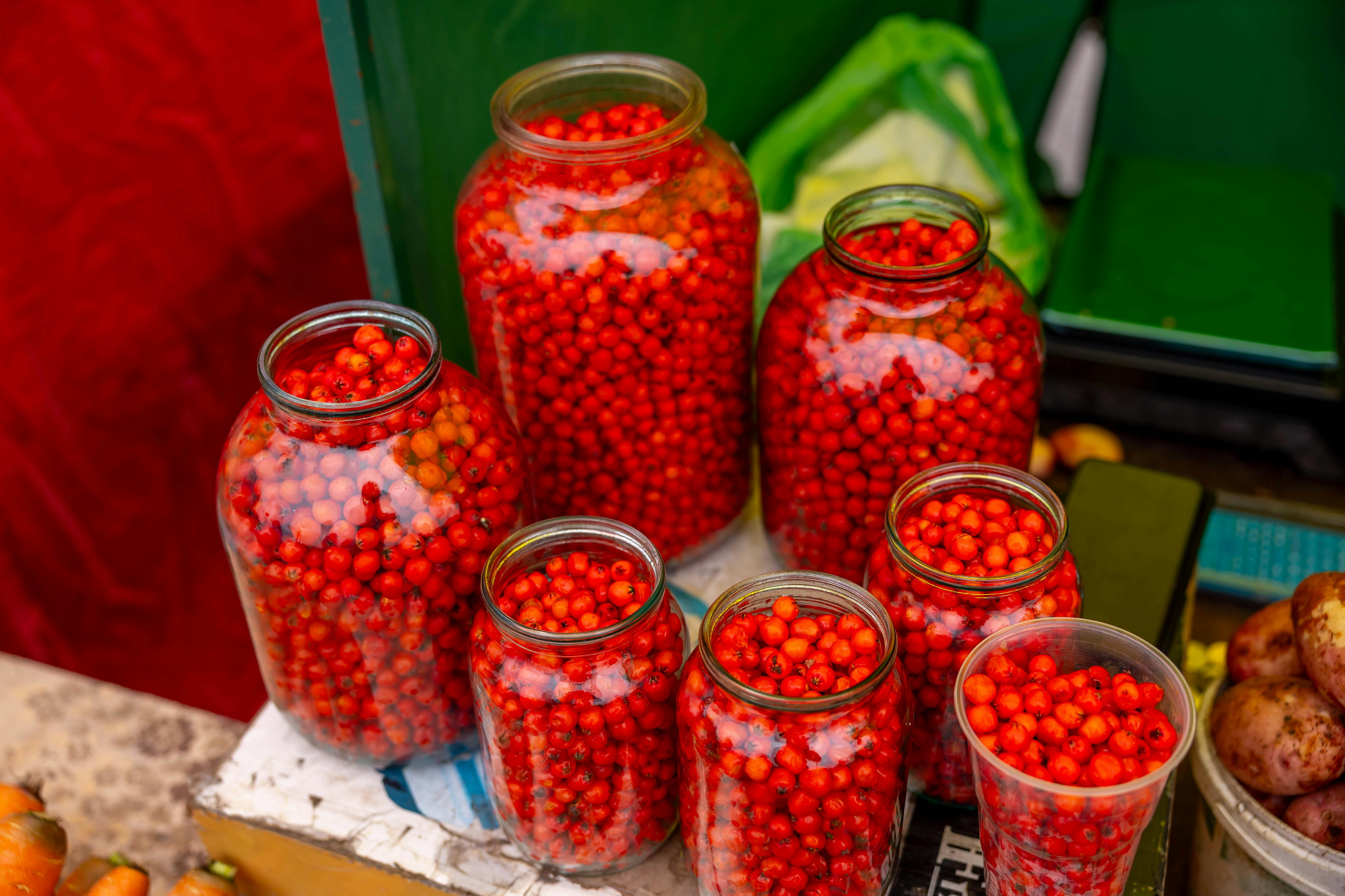 Vibrant Display of Red Berries in Glass Jars · Free Stock Photo