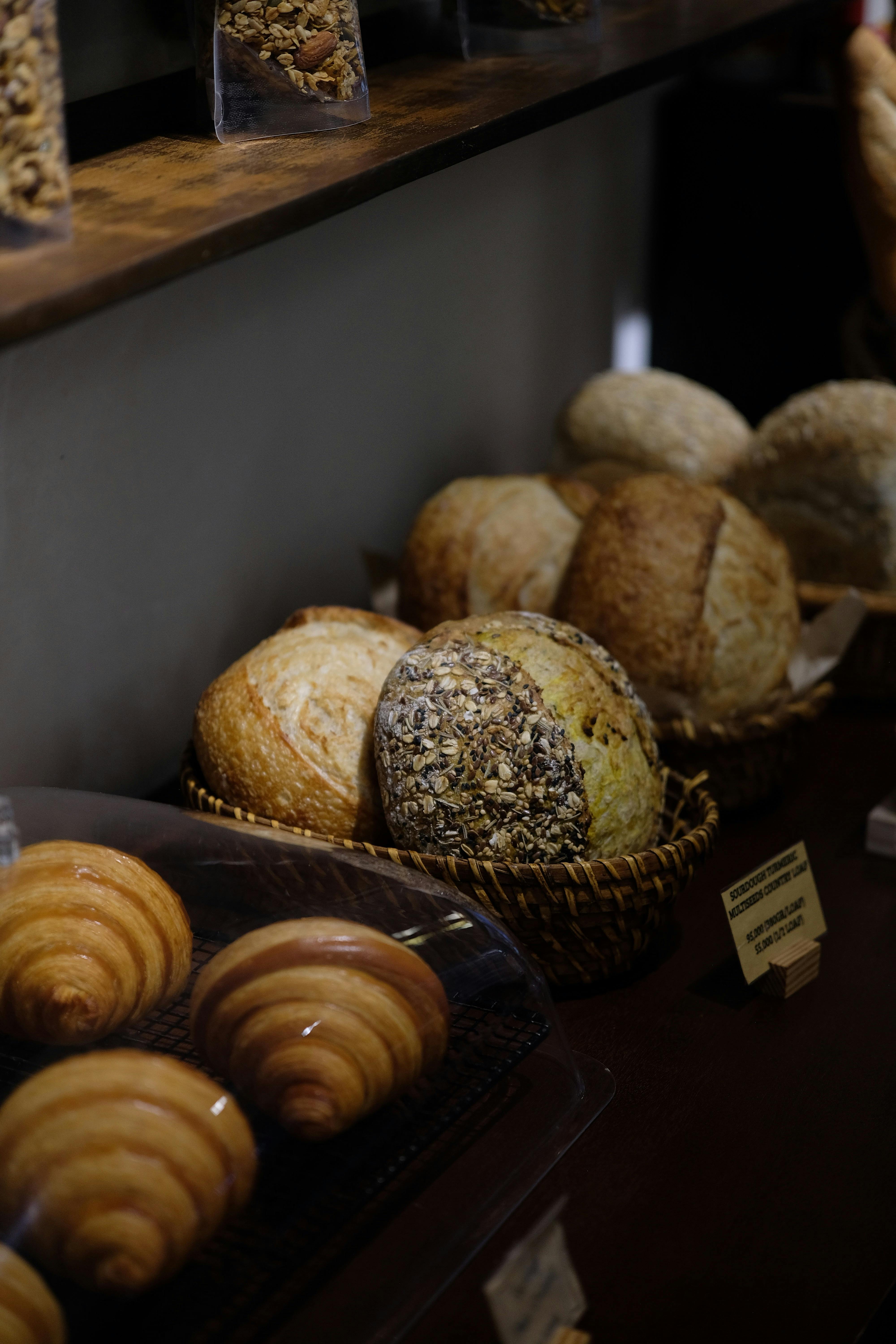 Artisanal Bread and Croissants in Bakery Display · Free Stock Photo