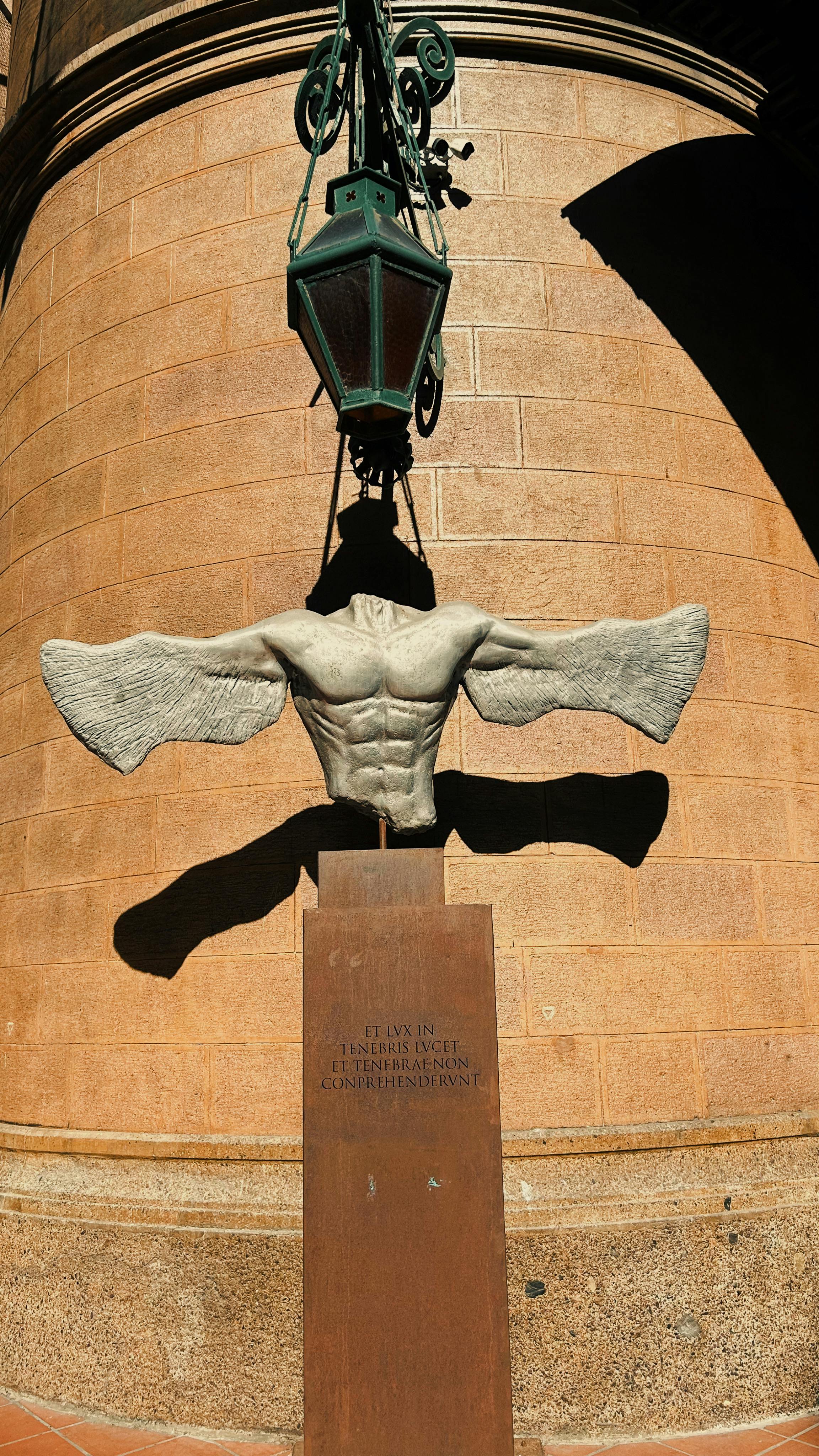 Sculpture of Winged Torso with Hanging Lantern · Free Stock Photo