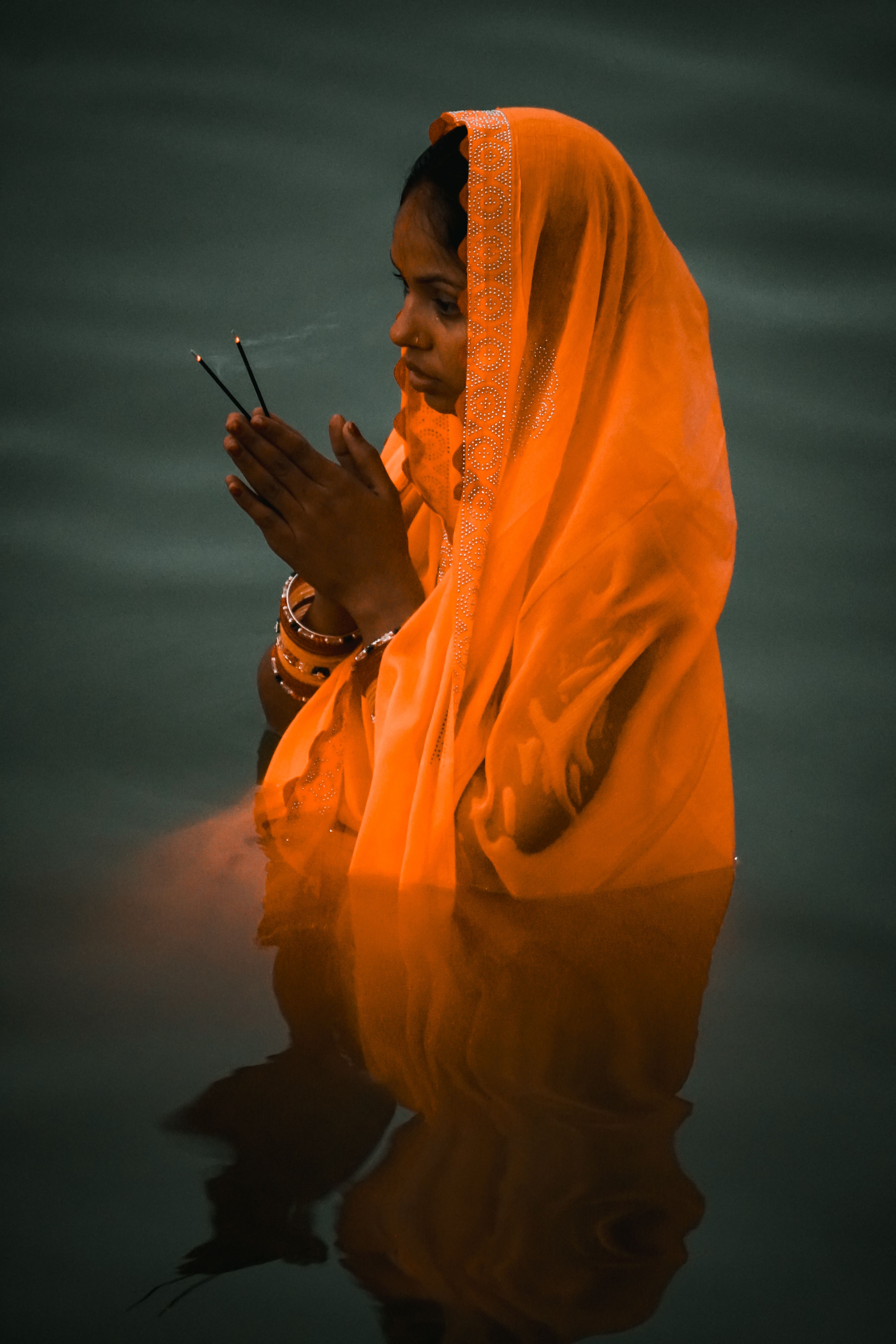 Woman in Traditional Sari Praying in Water · Free Stock Photo