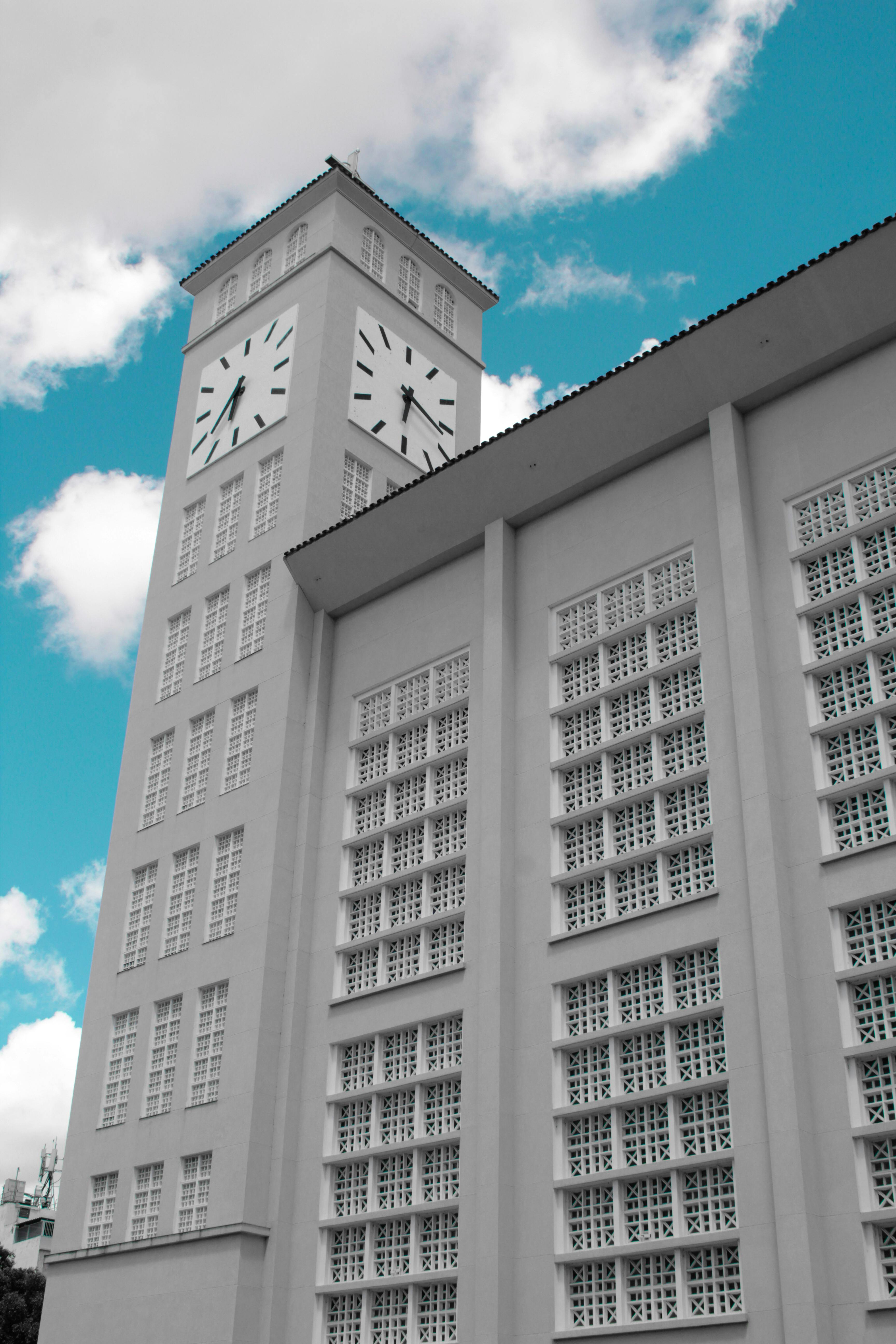Modern Clock Tower Against Blue Sky · Free Stock Photo