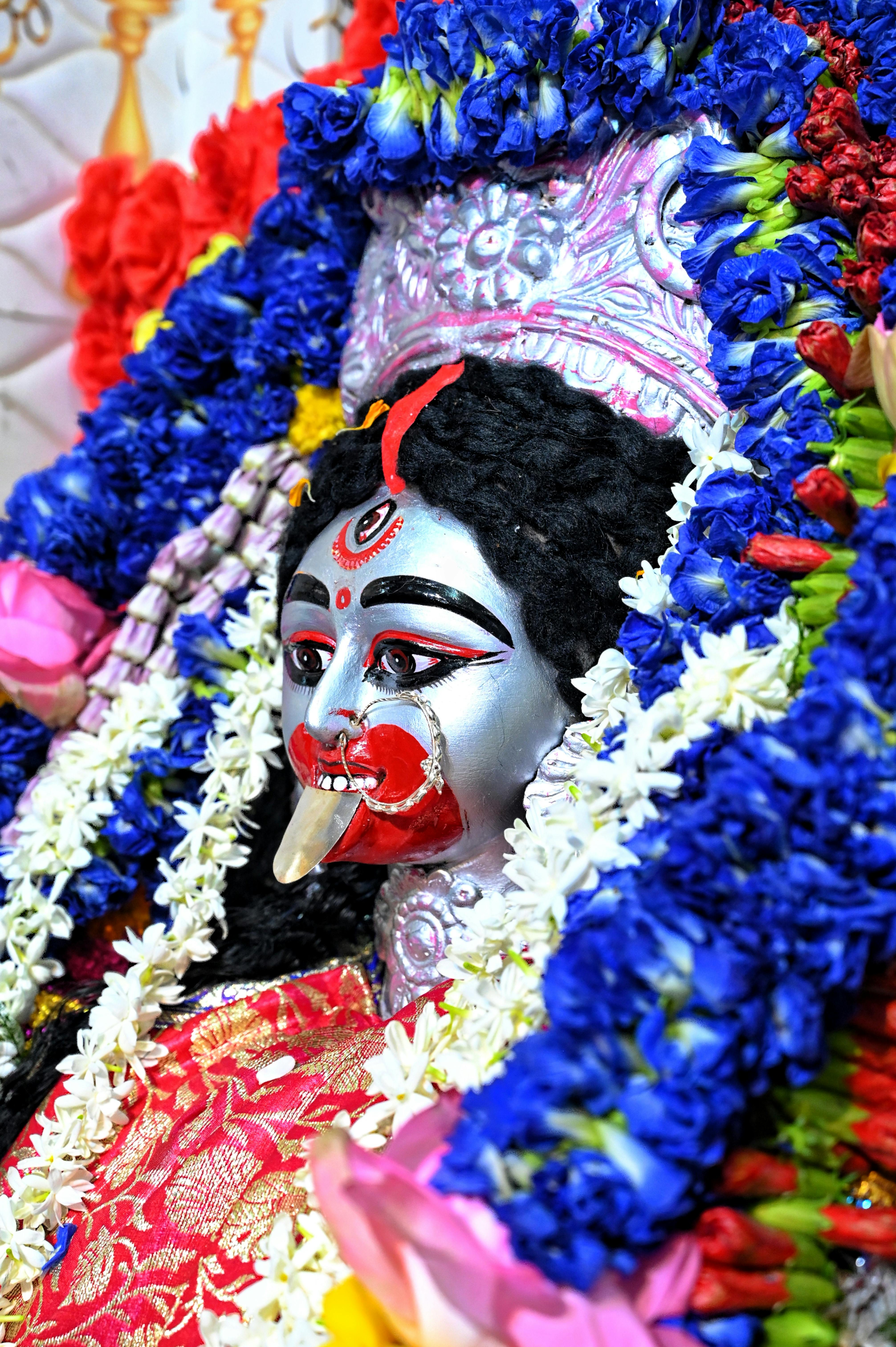 Colorful Goddess Statue Decorated with Flowers · Free Stock Photo