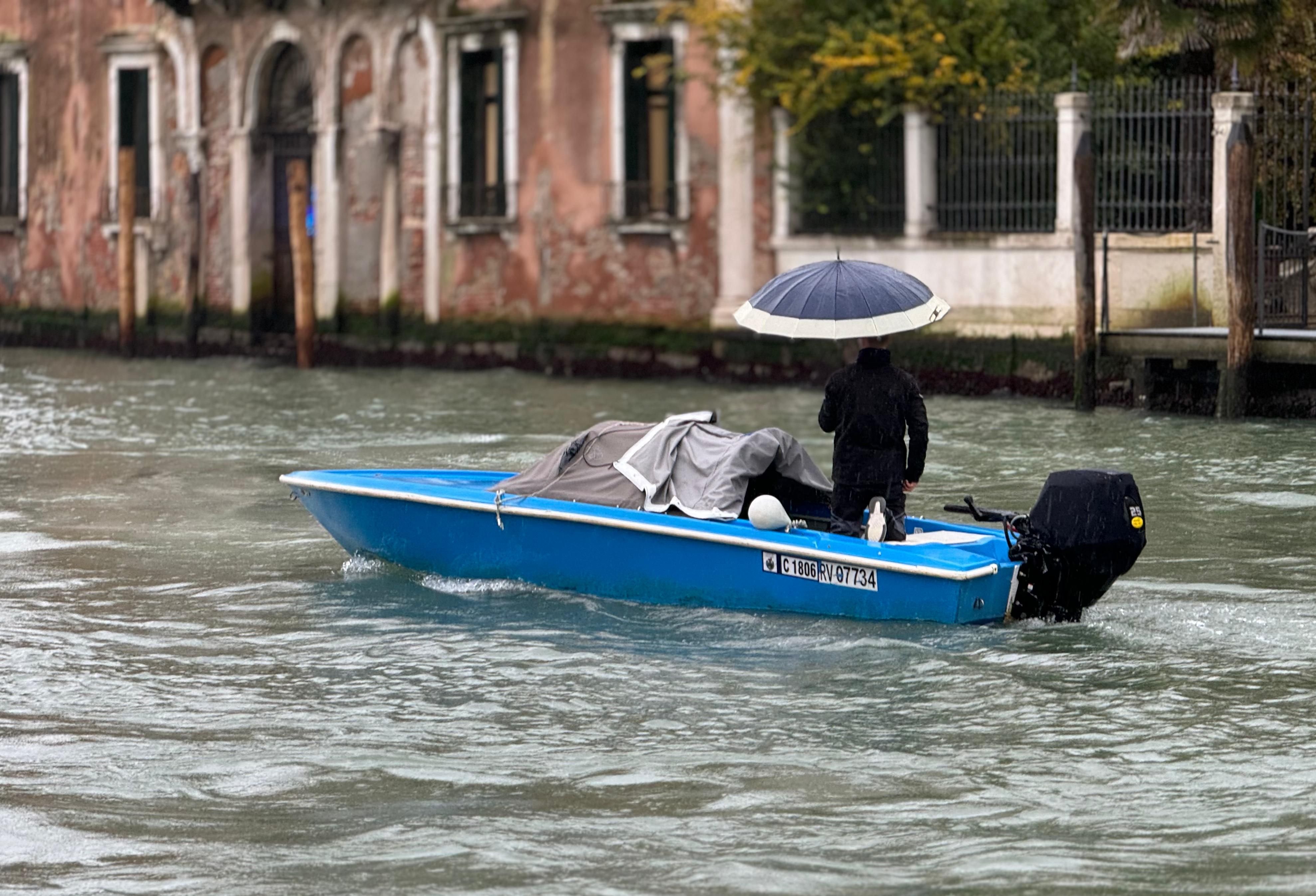 Venice Canal Scene: Blue Boat in Rain · Free Stock Photo