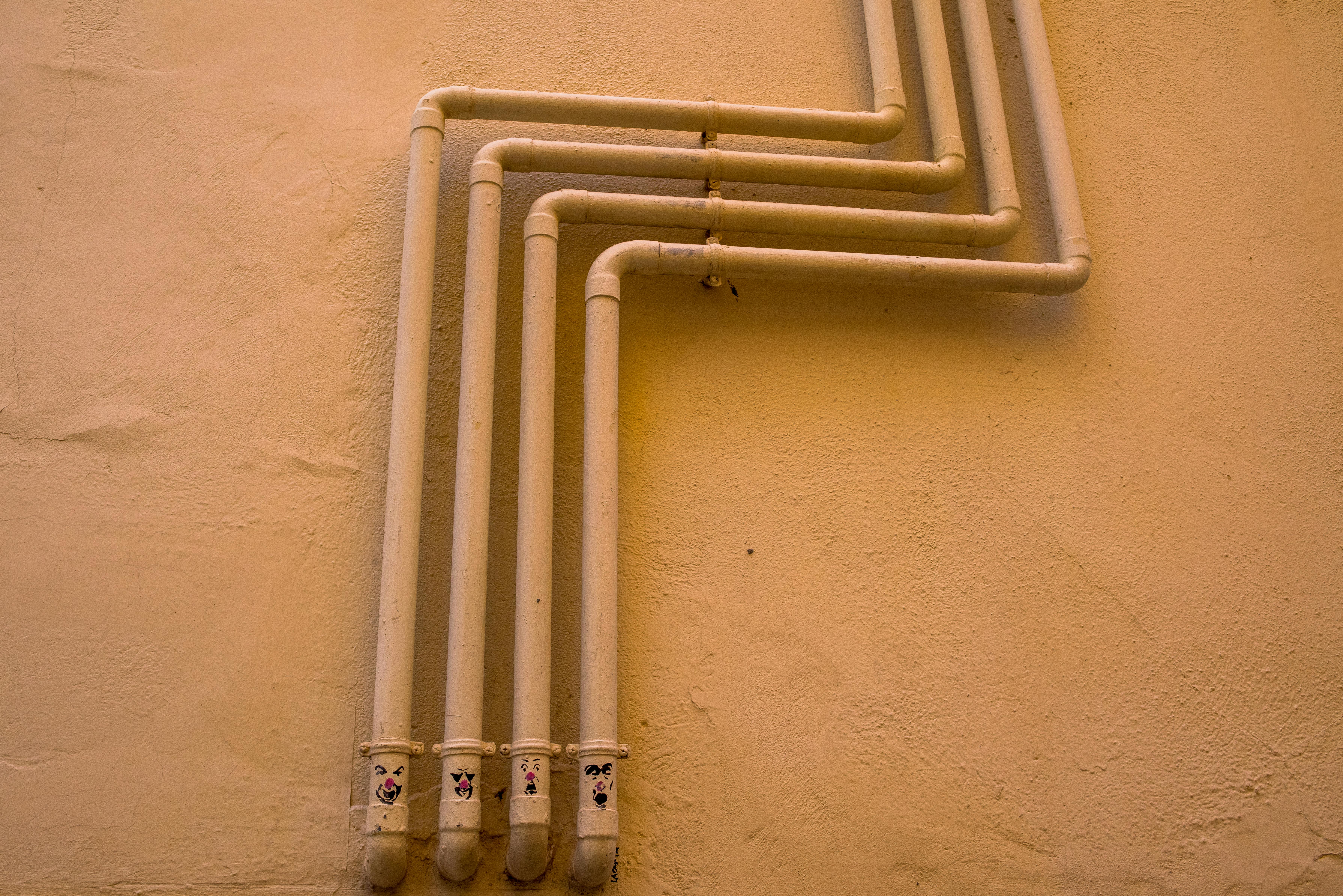 Minimalist Urban Pipes on Textured Wall · Free Stock Photo