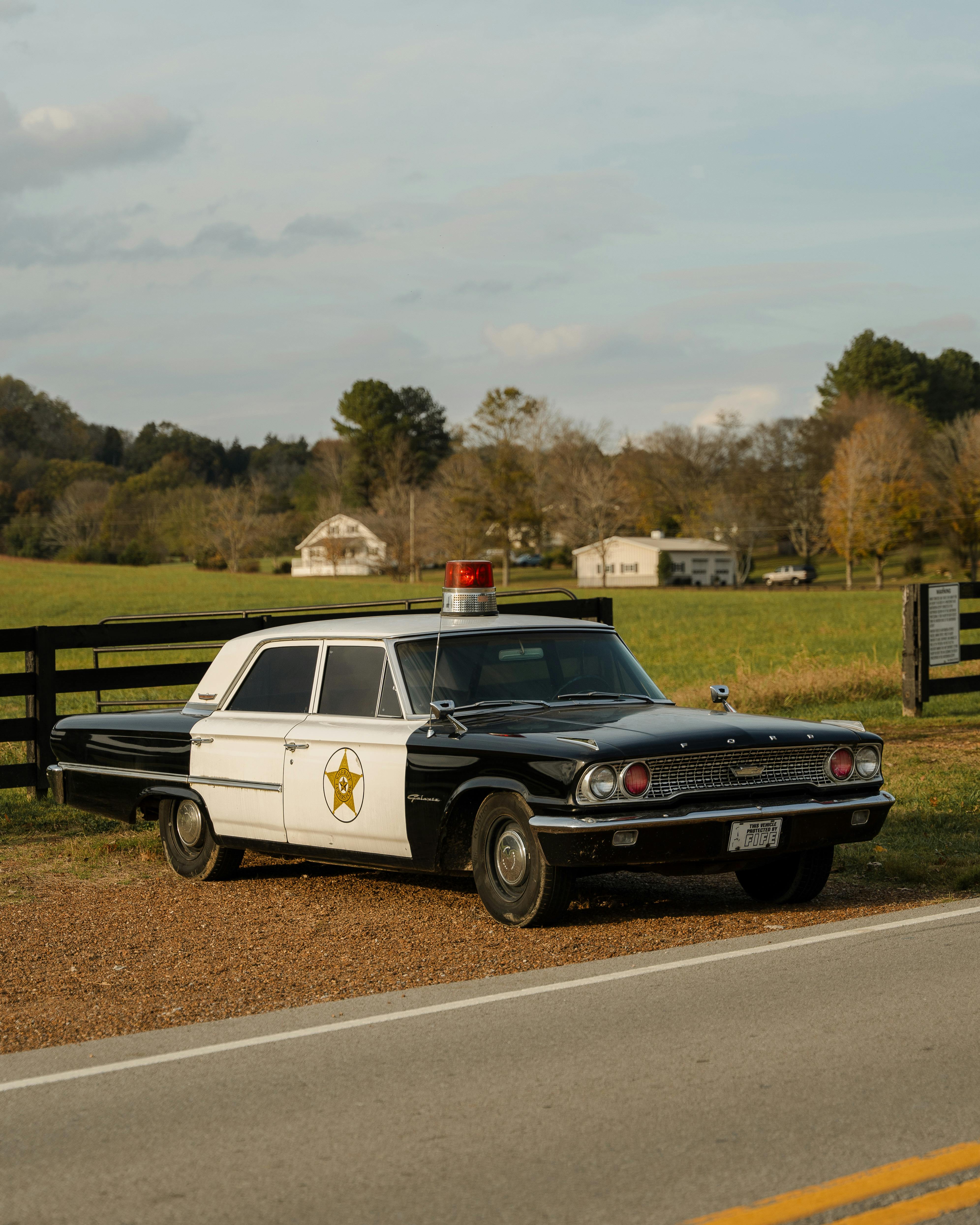 Vintage Police Car in Rural Setting · Free Stock Photo