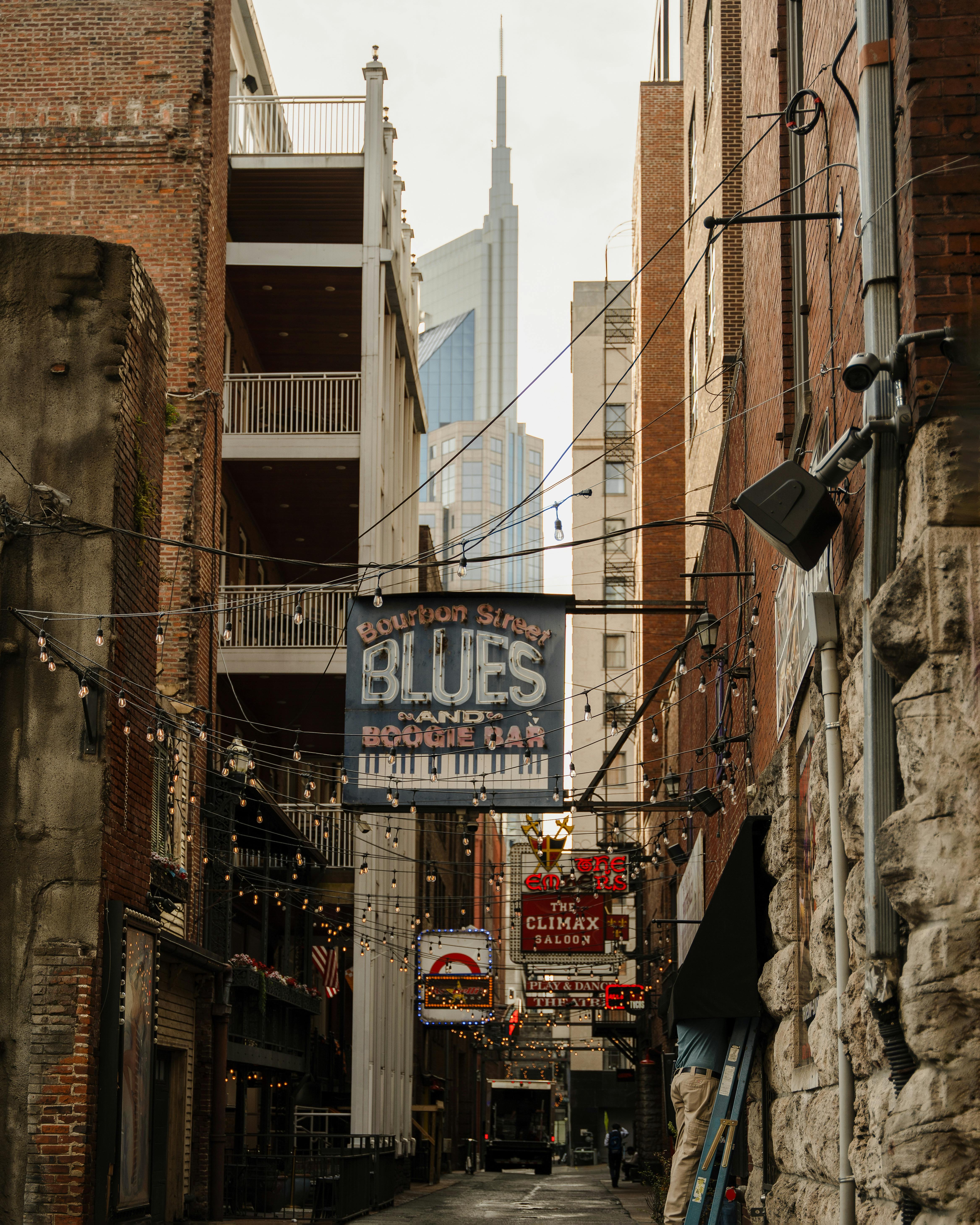 Urban Alleyway with Iconic Blues Bar Signs · Free Stock Photo
