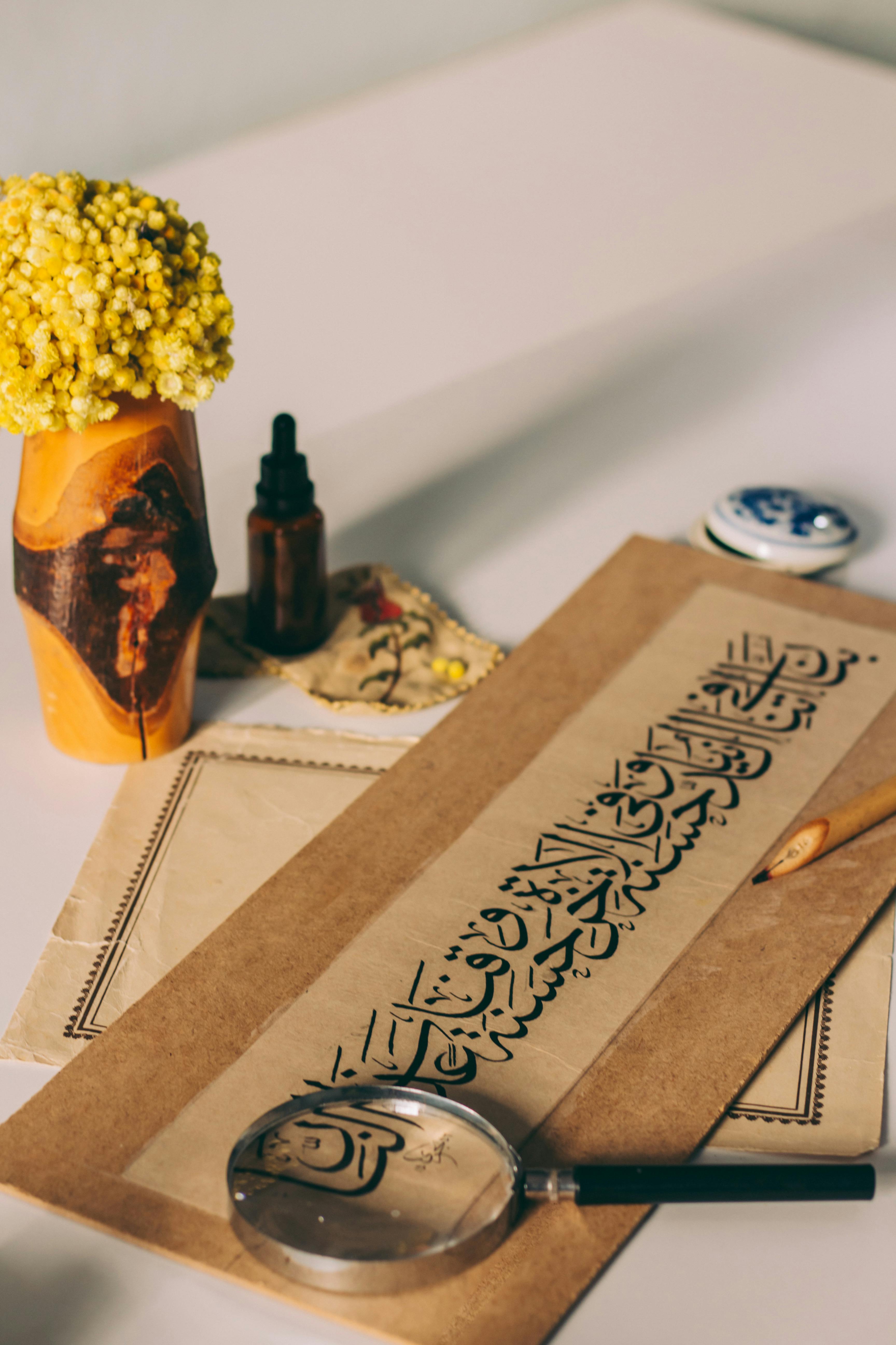 Artistic Arabic Calligraphy with Flower Arrangement · Free Stock Photo