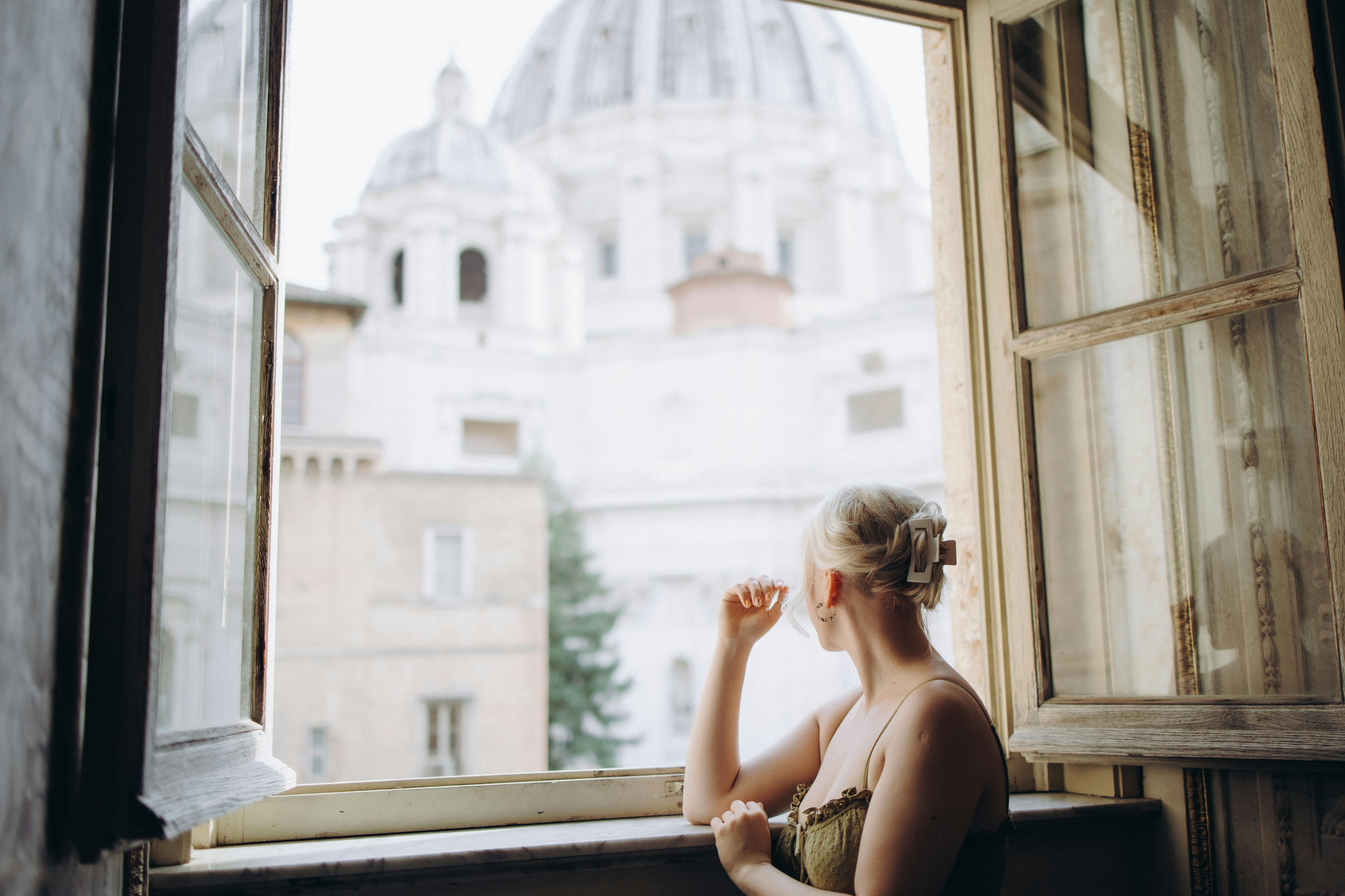 Woman gazing at St. Peter's Basilica in Vatican City · Free Stock Photo