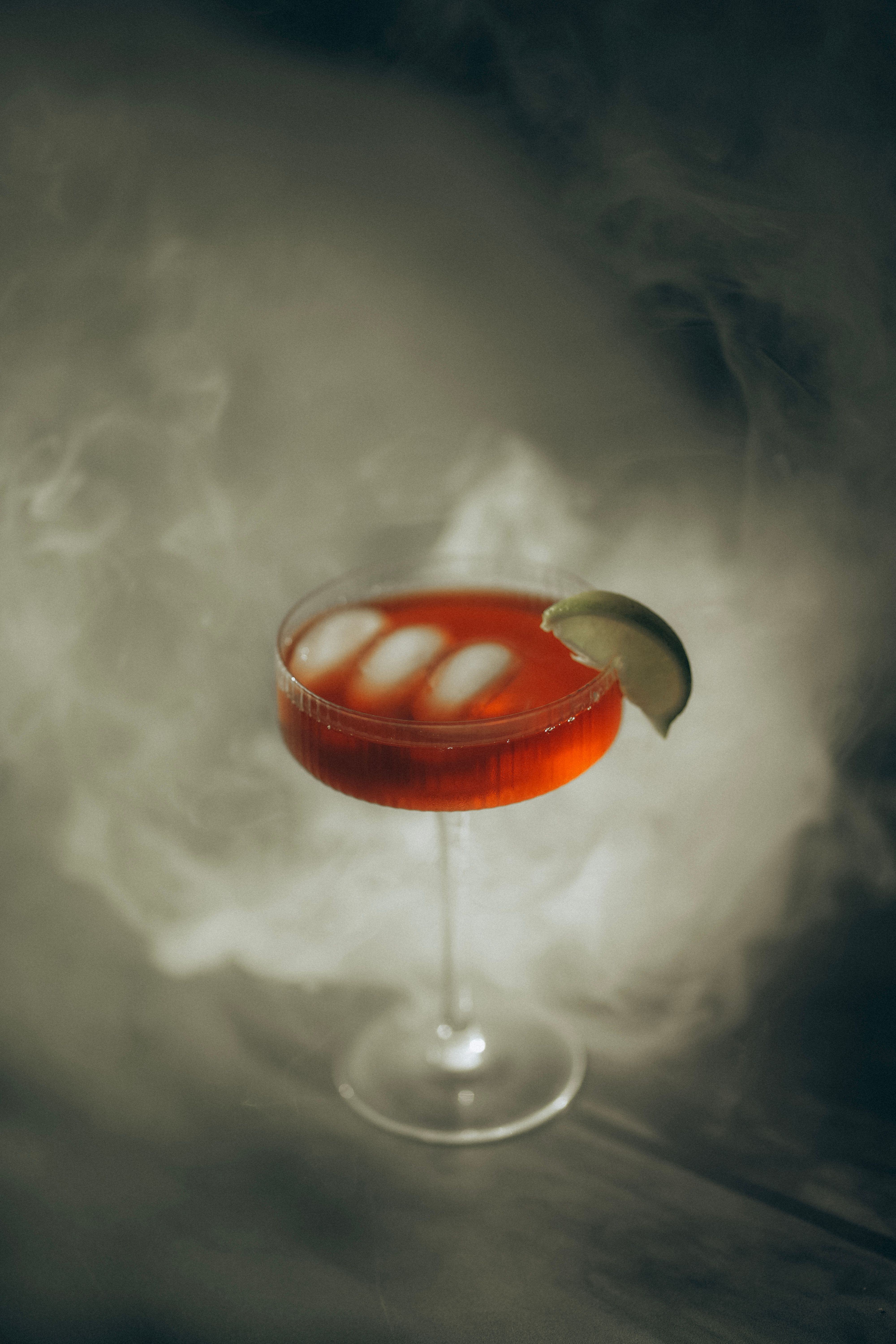 Misty Cocktail with Lime Garnish in Smokey Setting · Free Stock Photo