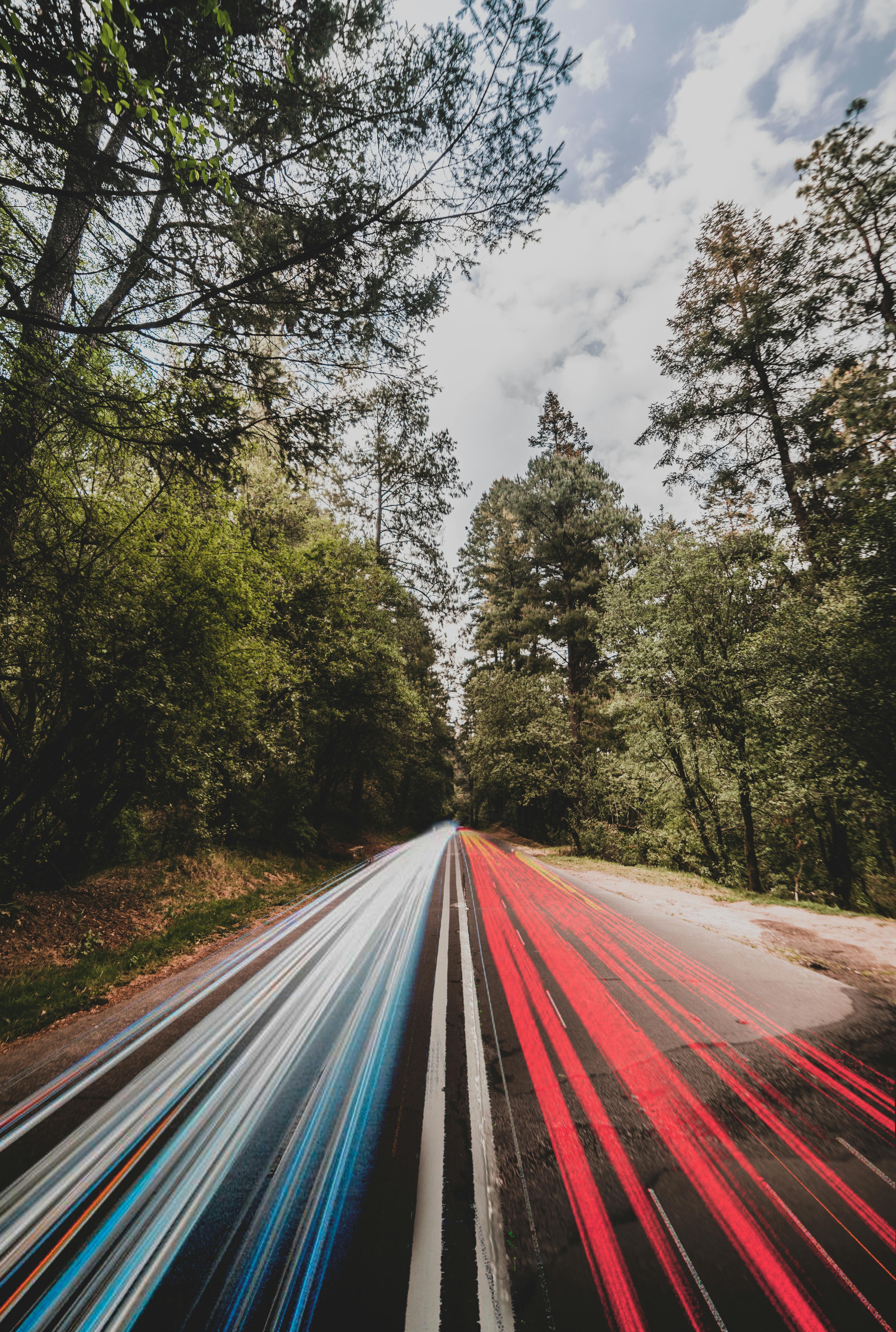 Forced Perspective Photography of Cars Running on Road Below Smartphone ...