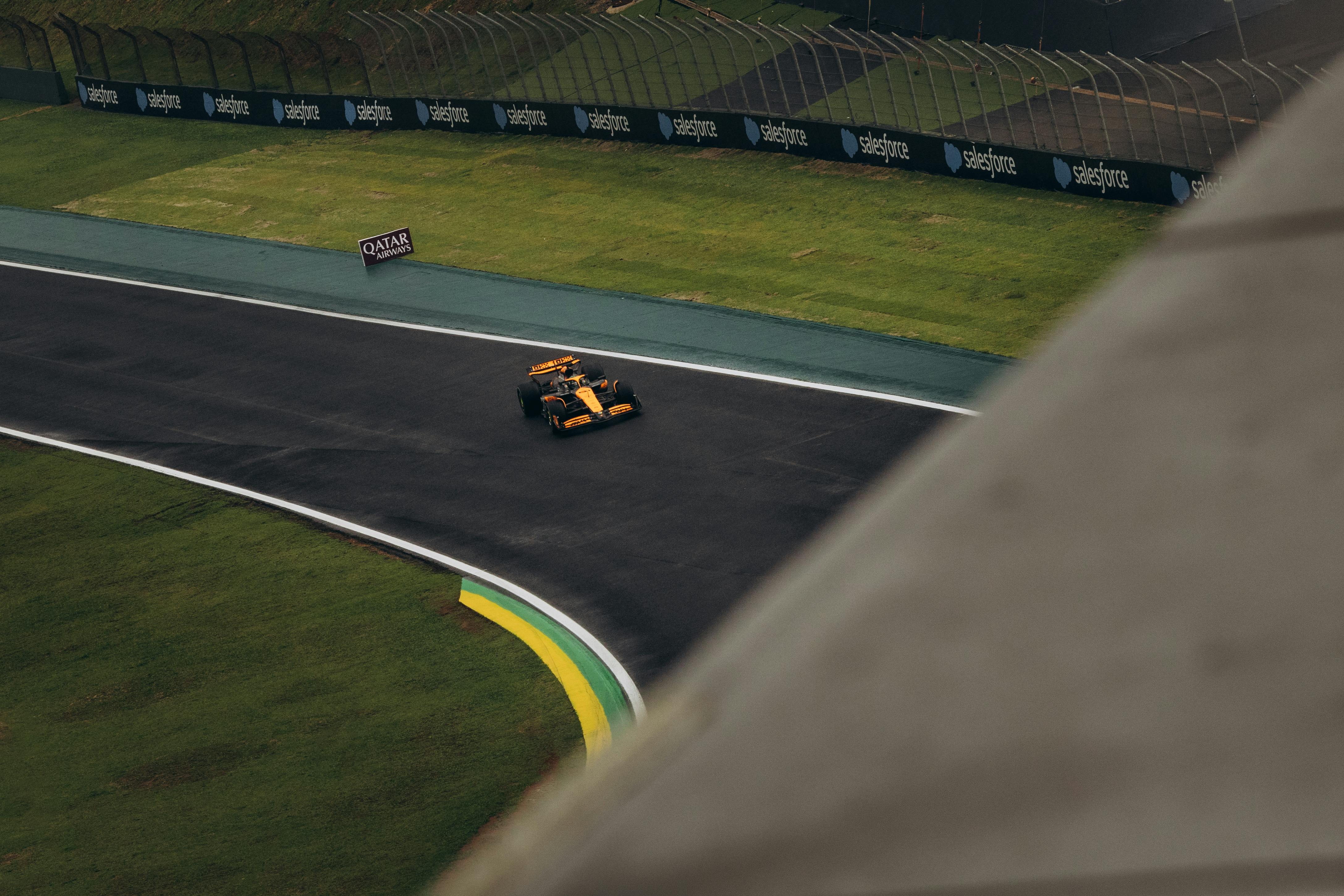 Aerial View of Formula 1 Car on Curved Track · Free Stock Photo