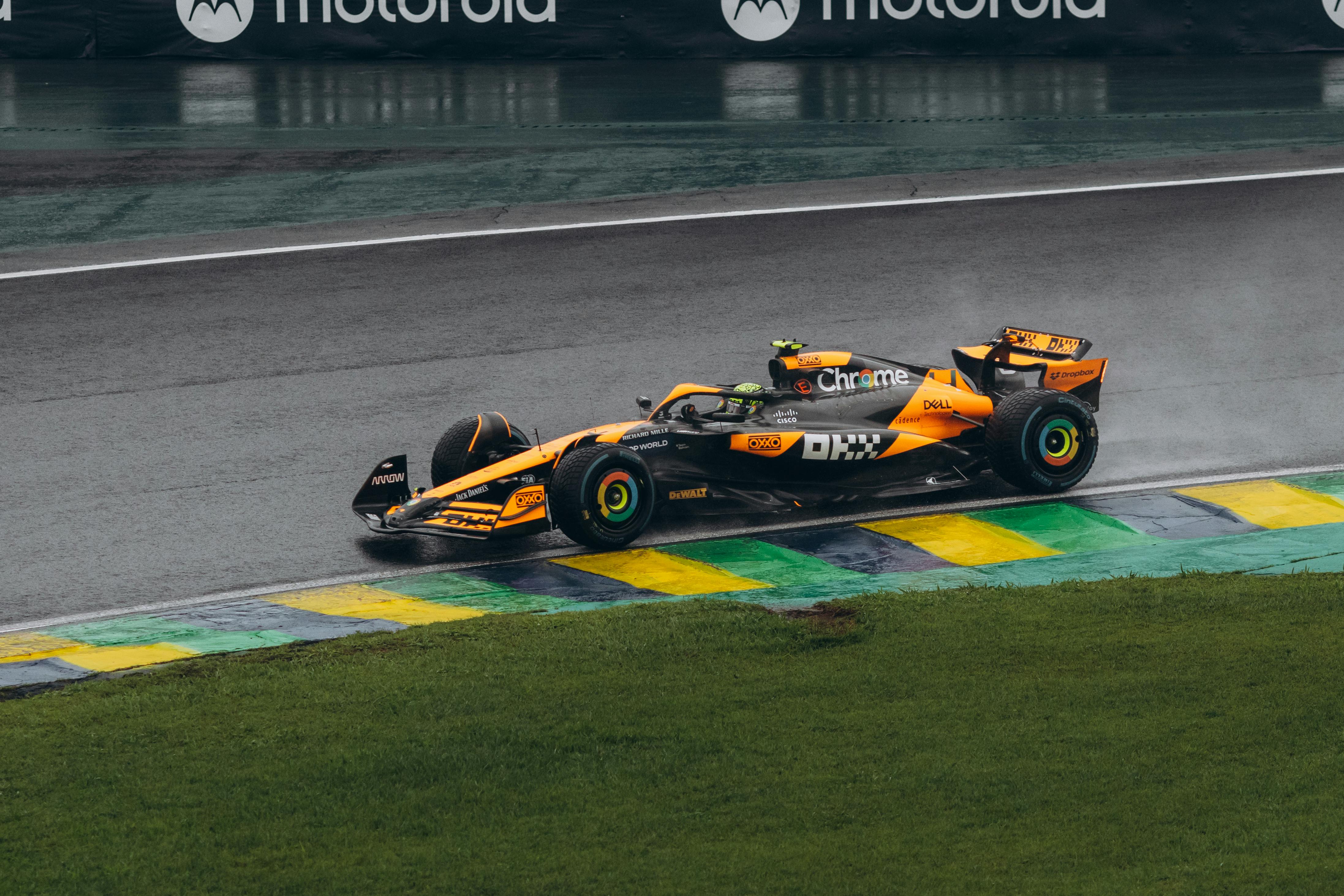 Monochrome Formula 1 Car Crossing Finish Line · Free Stock Photo