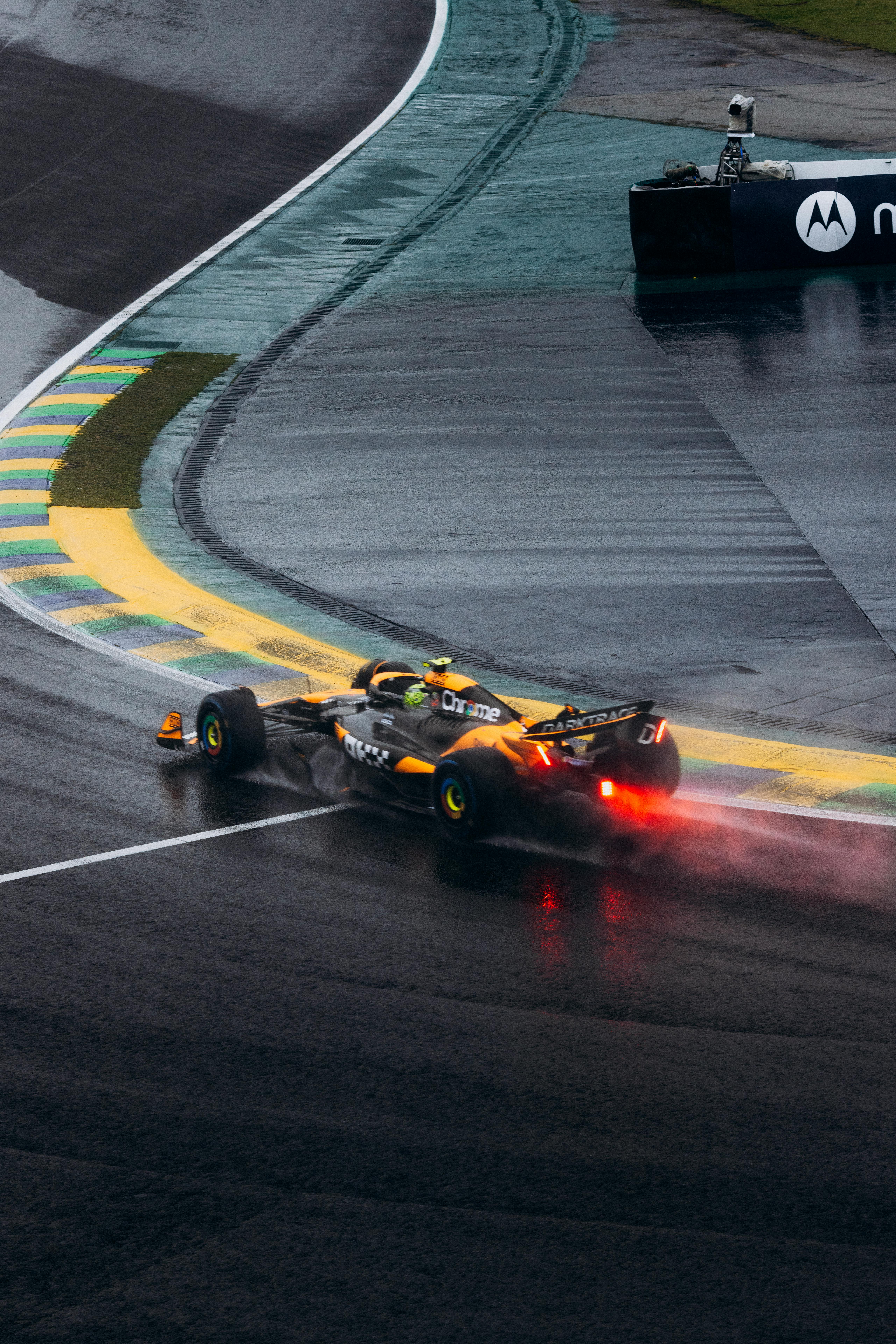 Monochrome Formula 1 Car Crossing Finish Line · Free Stock Photo