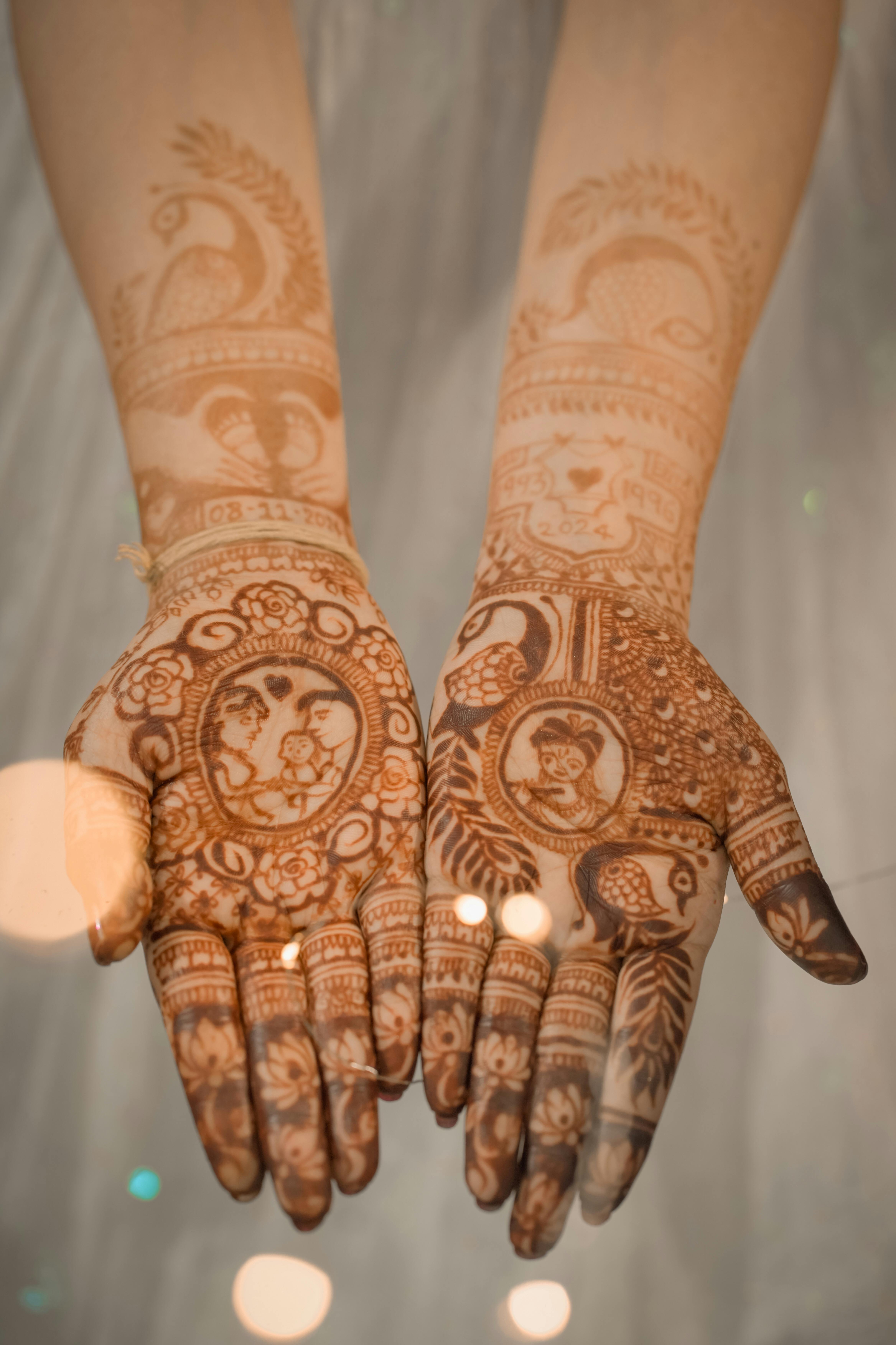 Intricate Henna Designs on Hands in Soft Light · Free Stock Photo