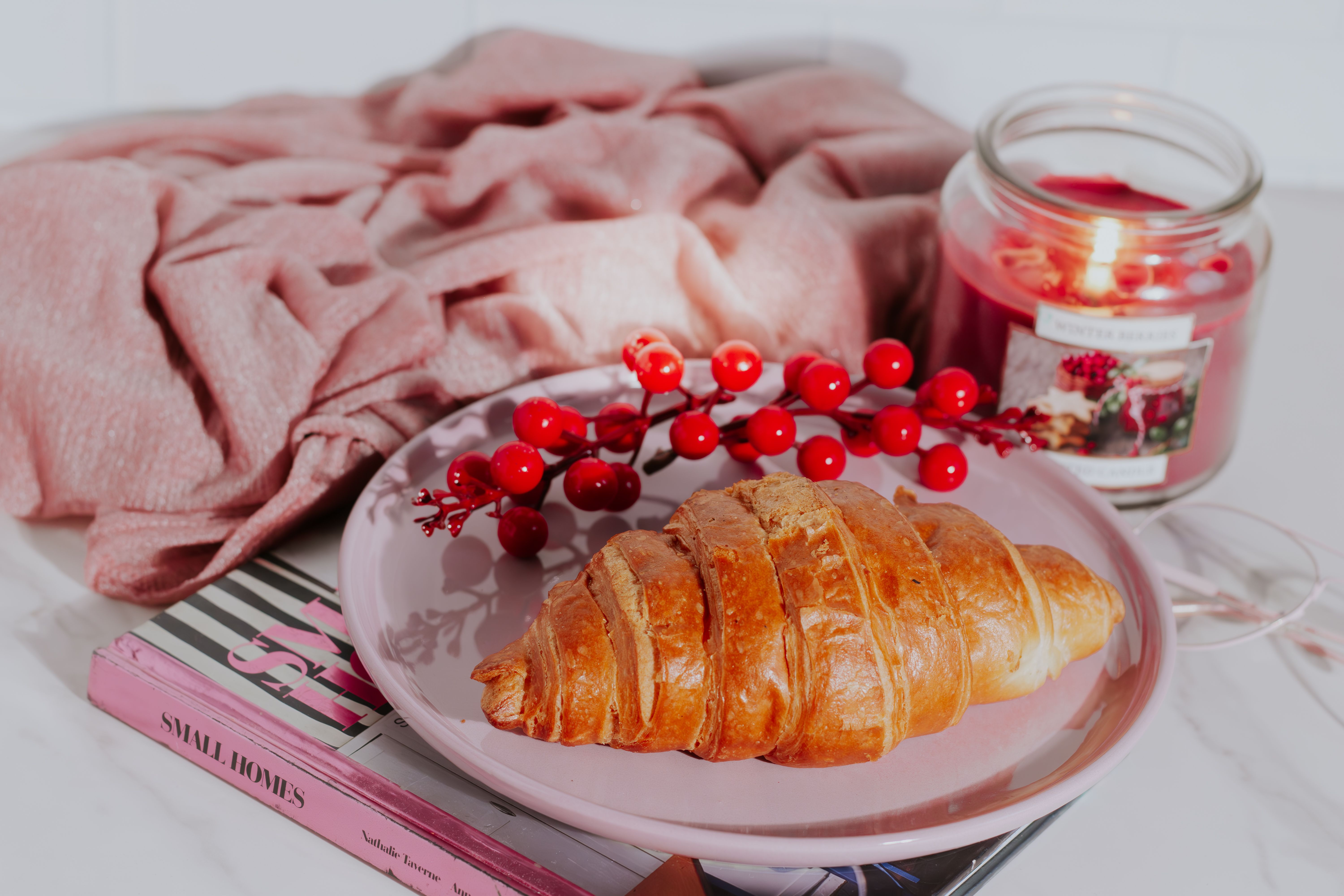 Cozy Morning Setup with Croissant and Candle · Free Stock Photo