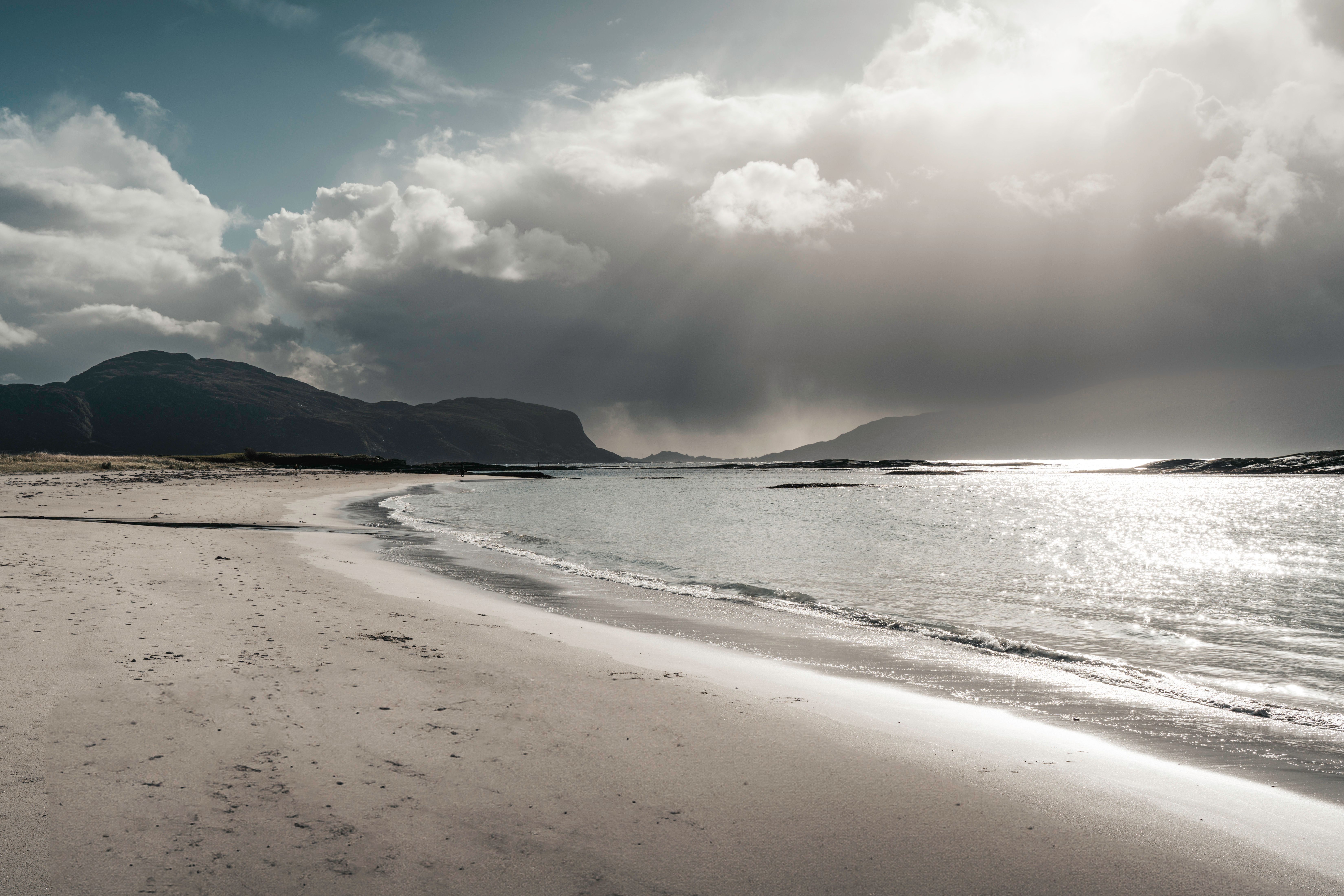 Dramatic Coastal Landscape with Sun Flare · Free Stock Photo