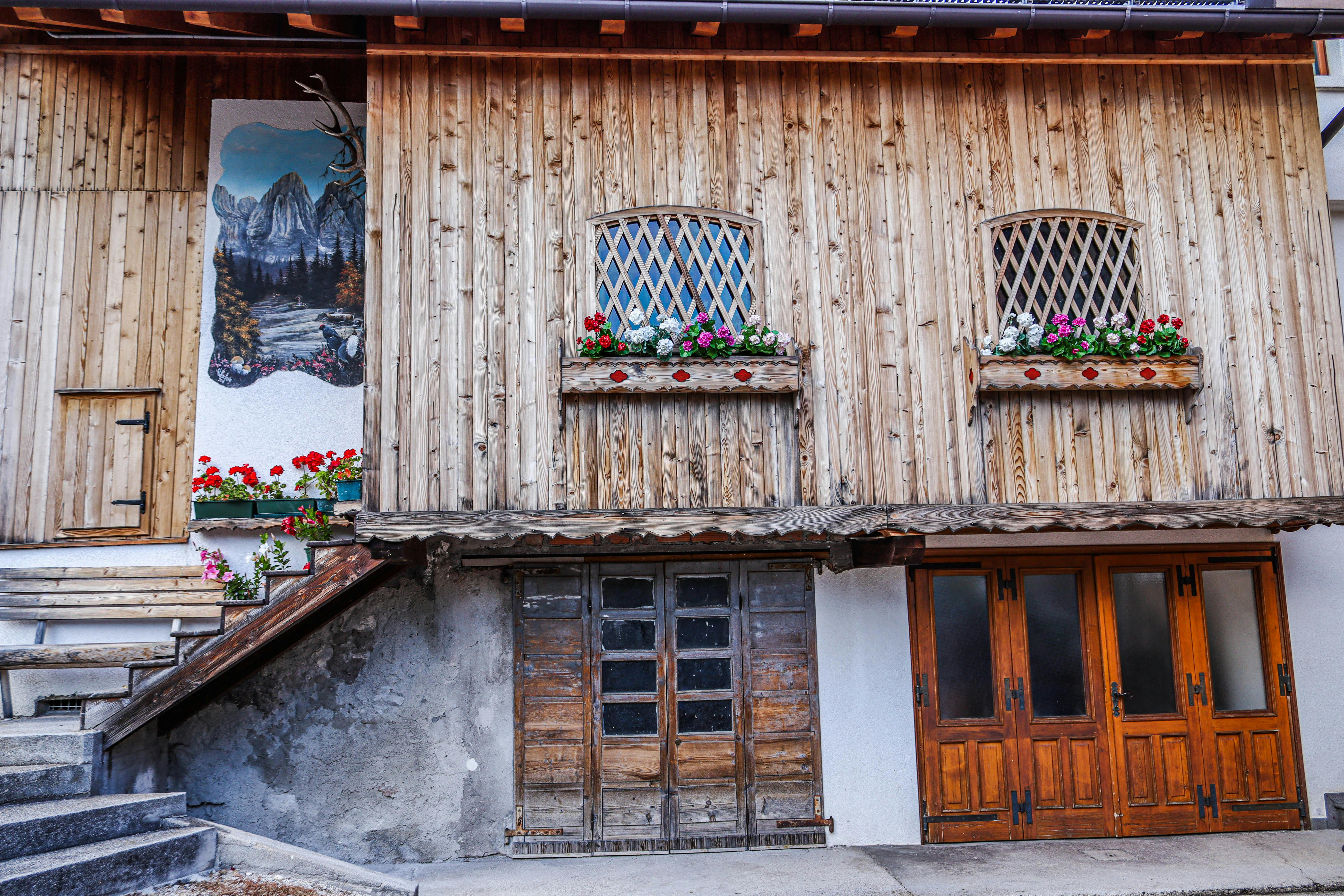 Rustic Wooden House Facade with Floral Decor · Free Stock Photo