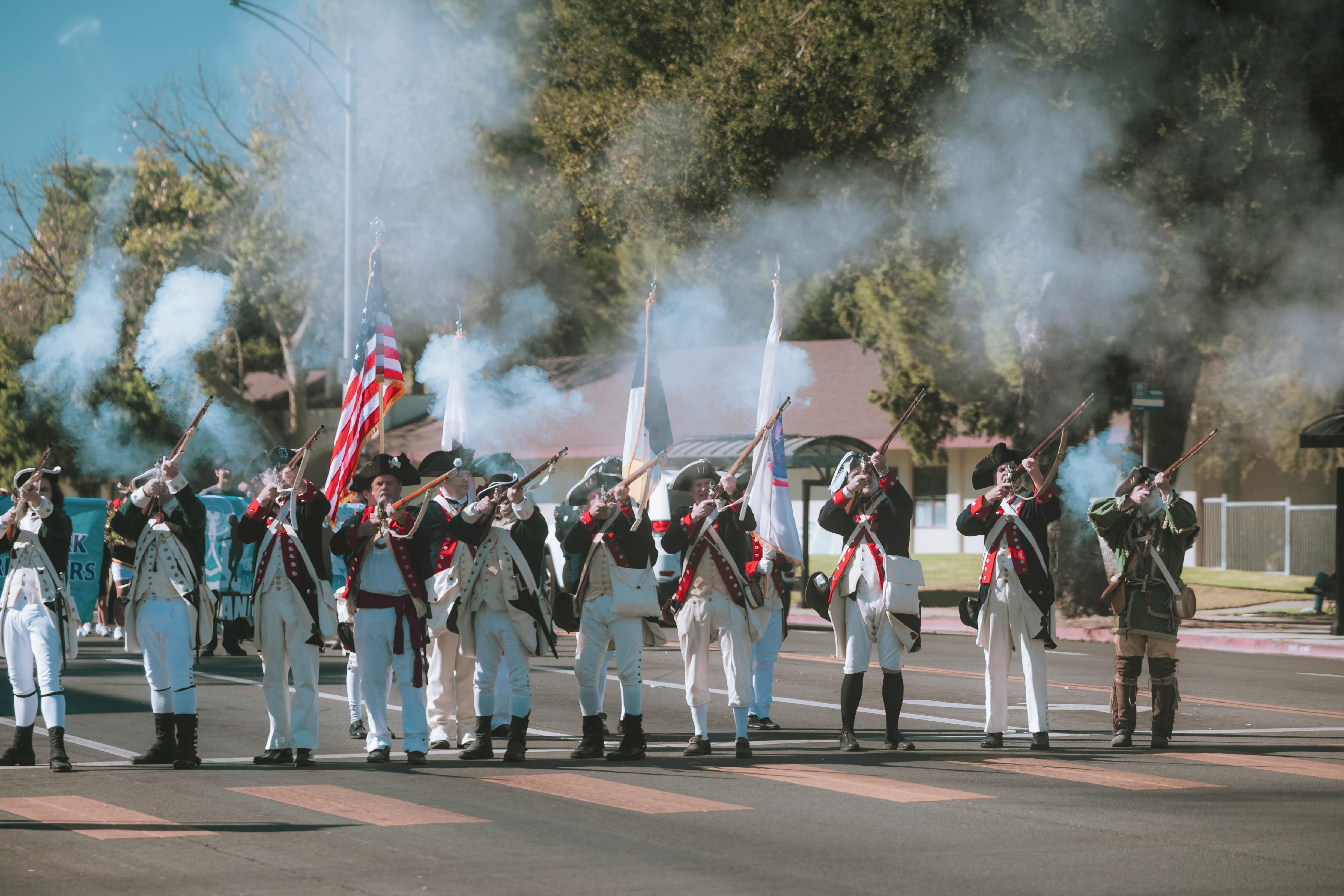 Historical Reenactment Parade with Musket Firing · Free Stock Photo