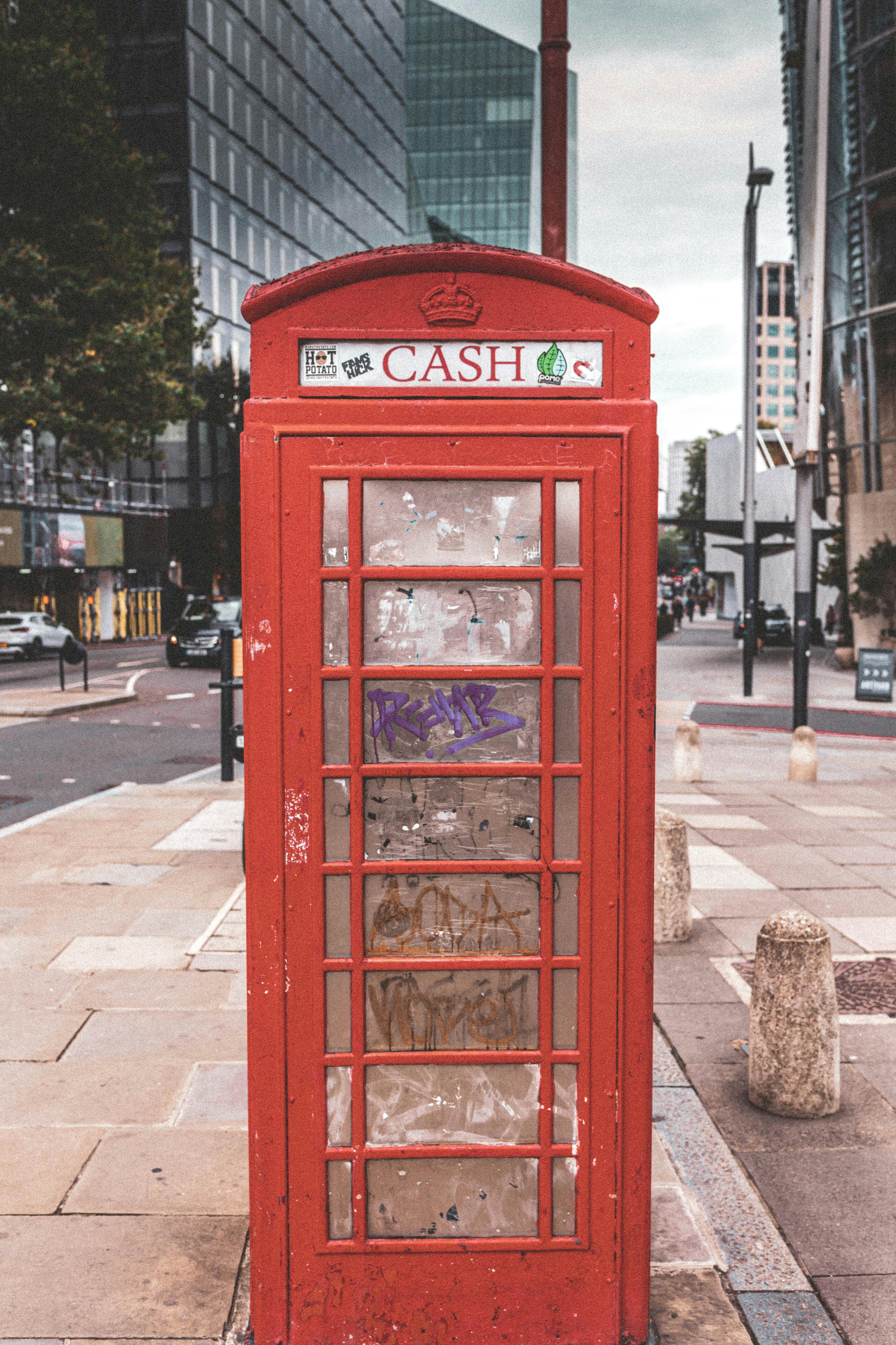 Classic Red Telephone Box in Modern Urban Setting · Free Stock Photo