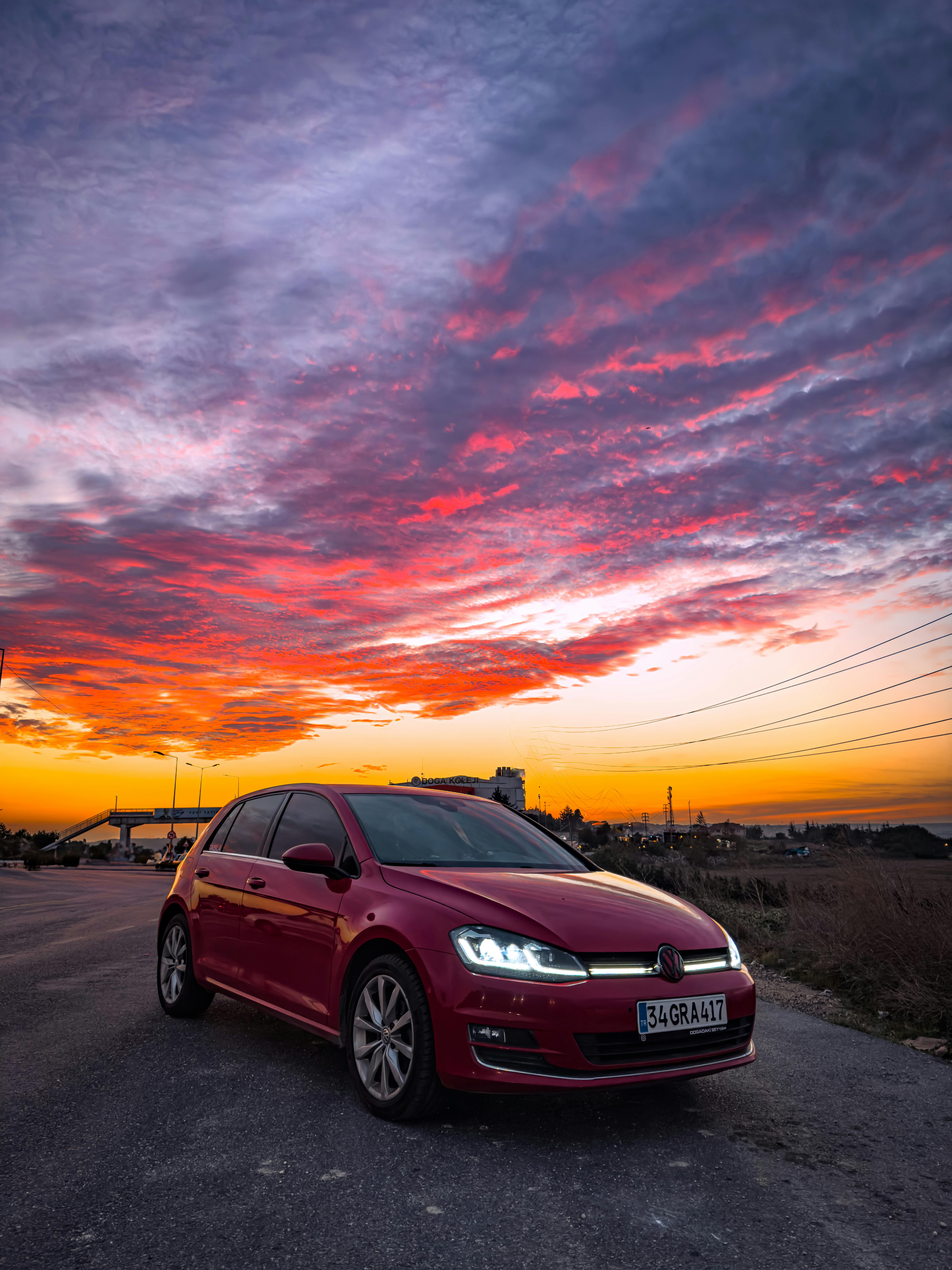 Red Car Against a Vibrant Sunset Sky · Free Stock Photo