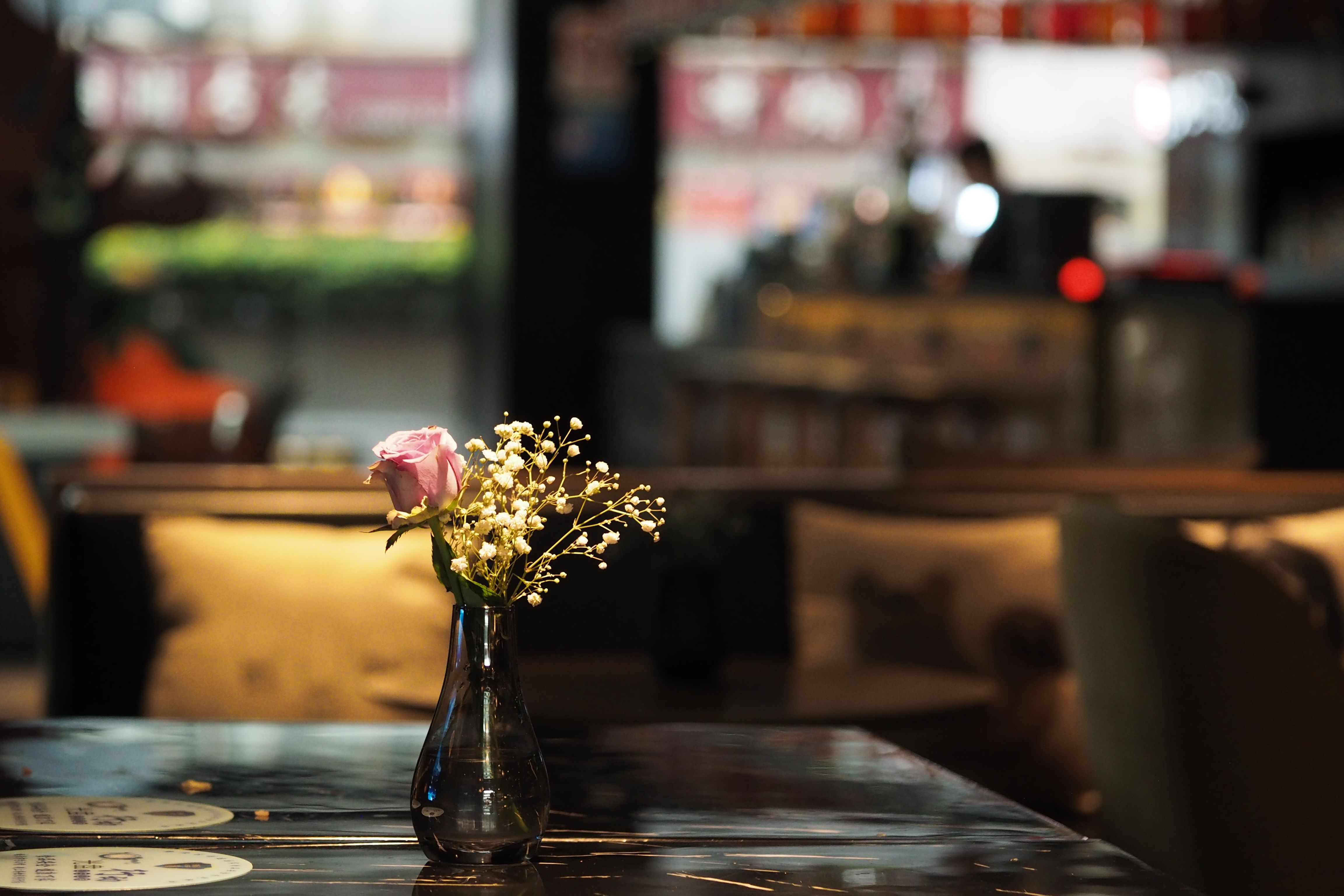 Elegant Rose in Vase on Café Table · Free Stock Photo