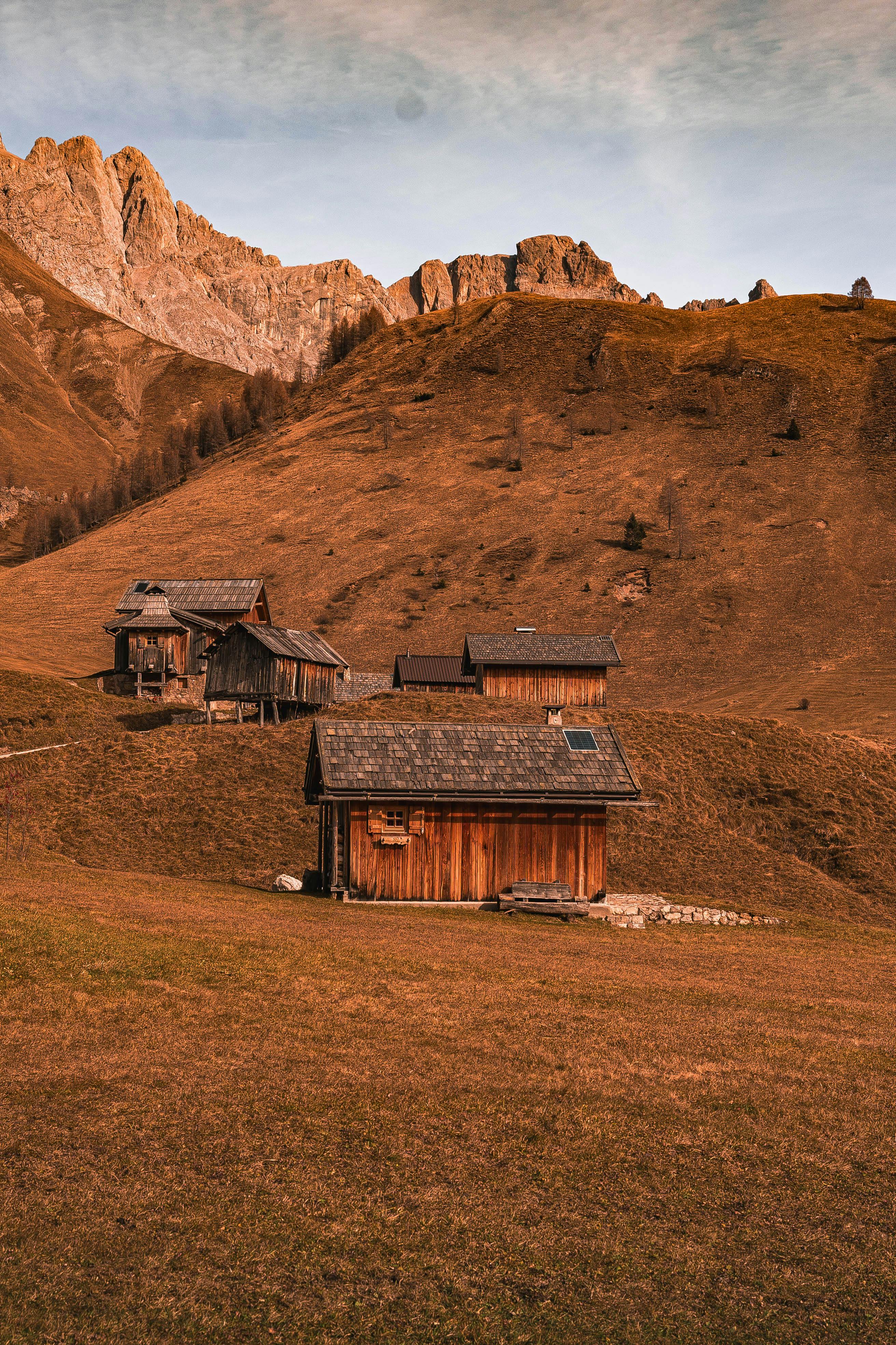 Rustic alpine cabins in mountainous landscape · Free Stock Photo