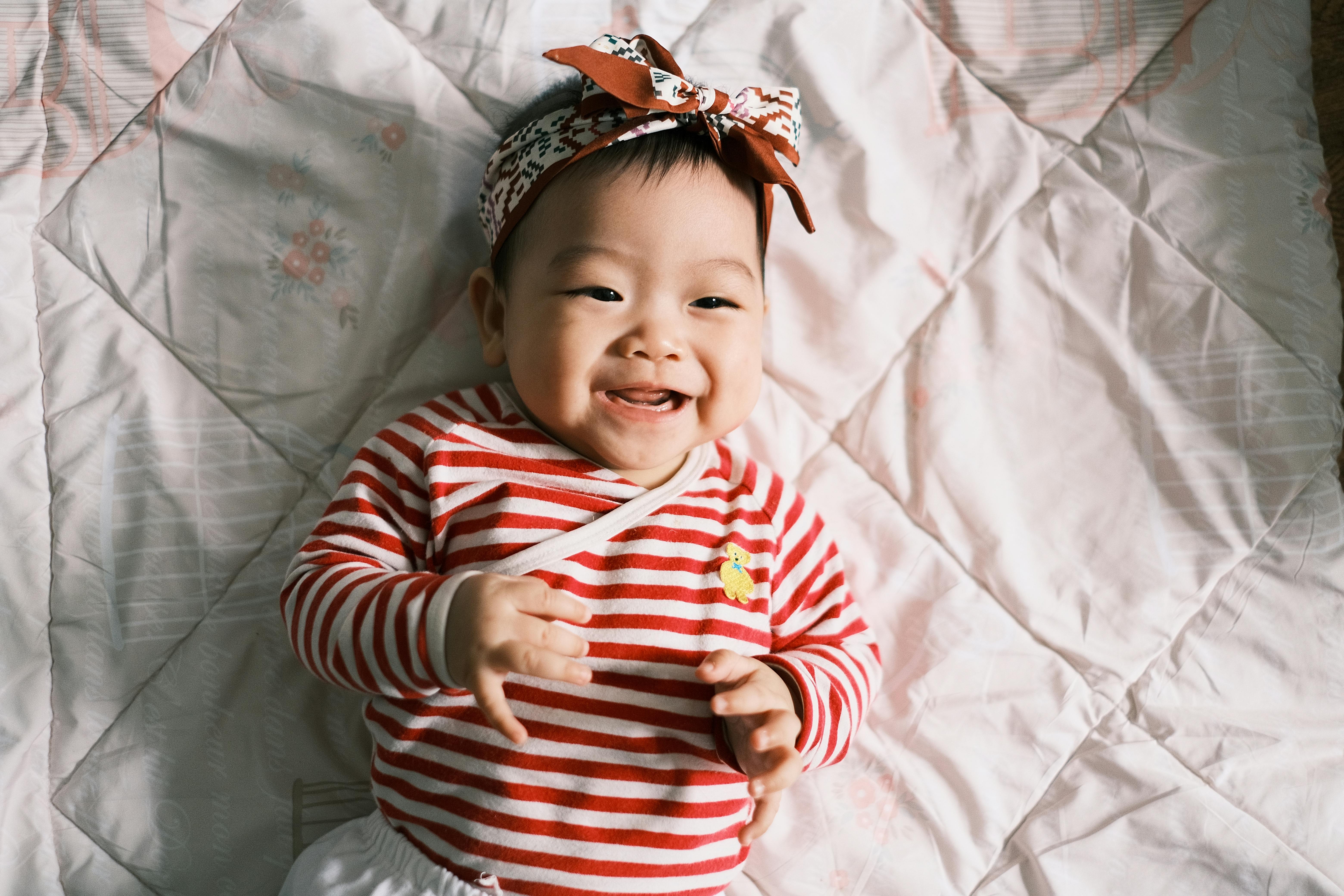 Smiling Baby Biting Right Index Finger · Free Stock Photo