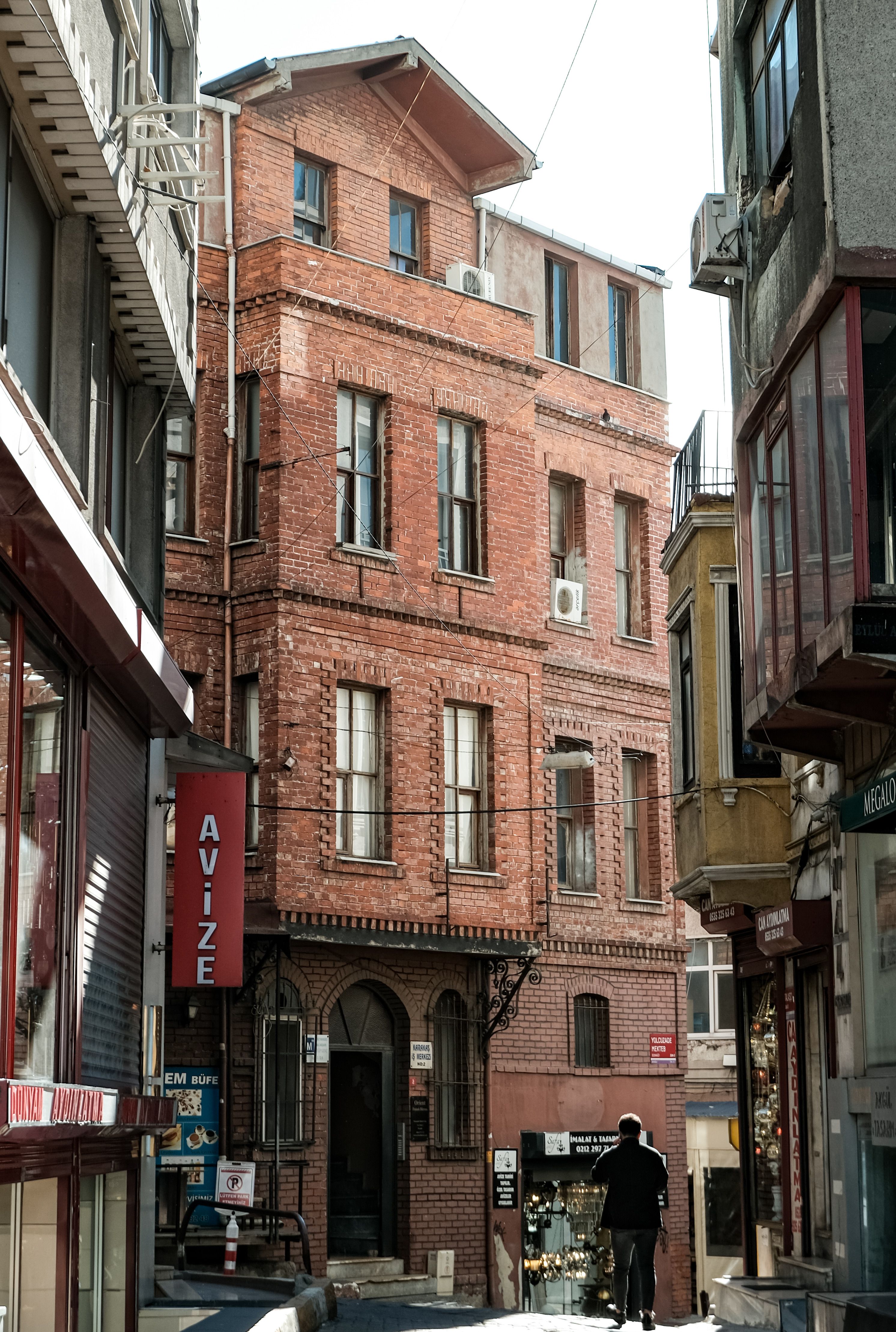 Historic Red Brick Building on Narrow Street · Free Stock Photo