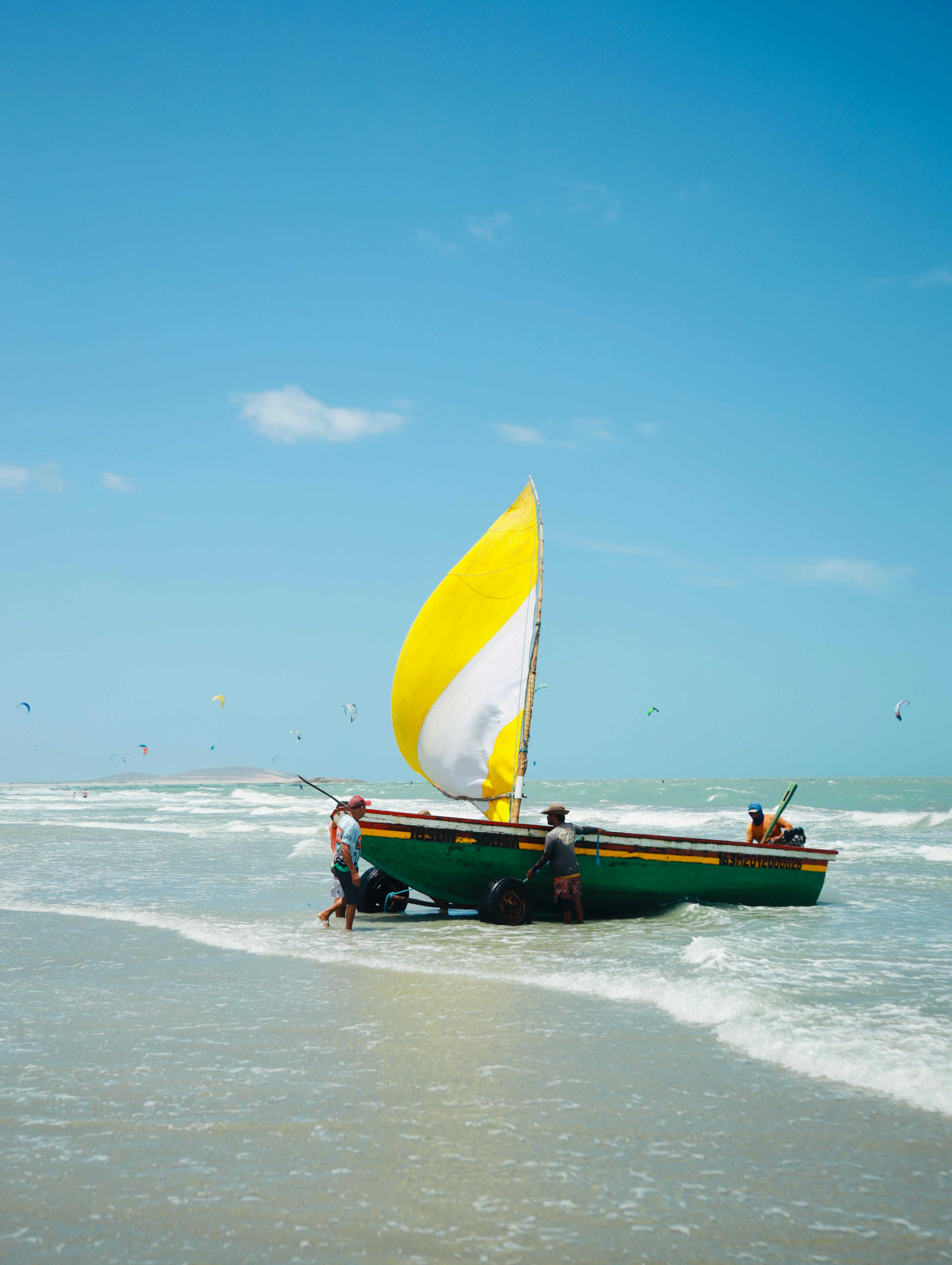 Seaside Sailboat with Bright Yellow Sail · Free Stock Photo