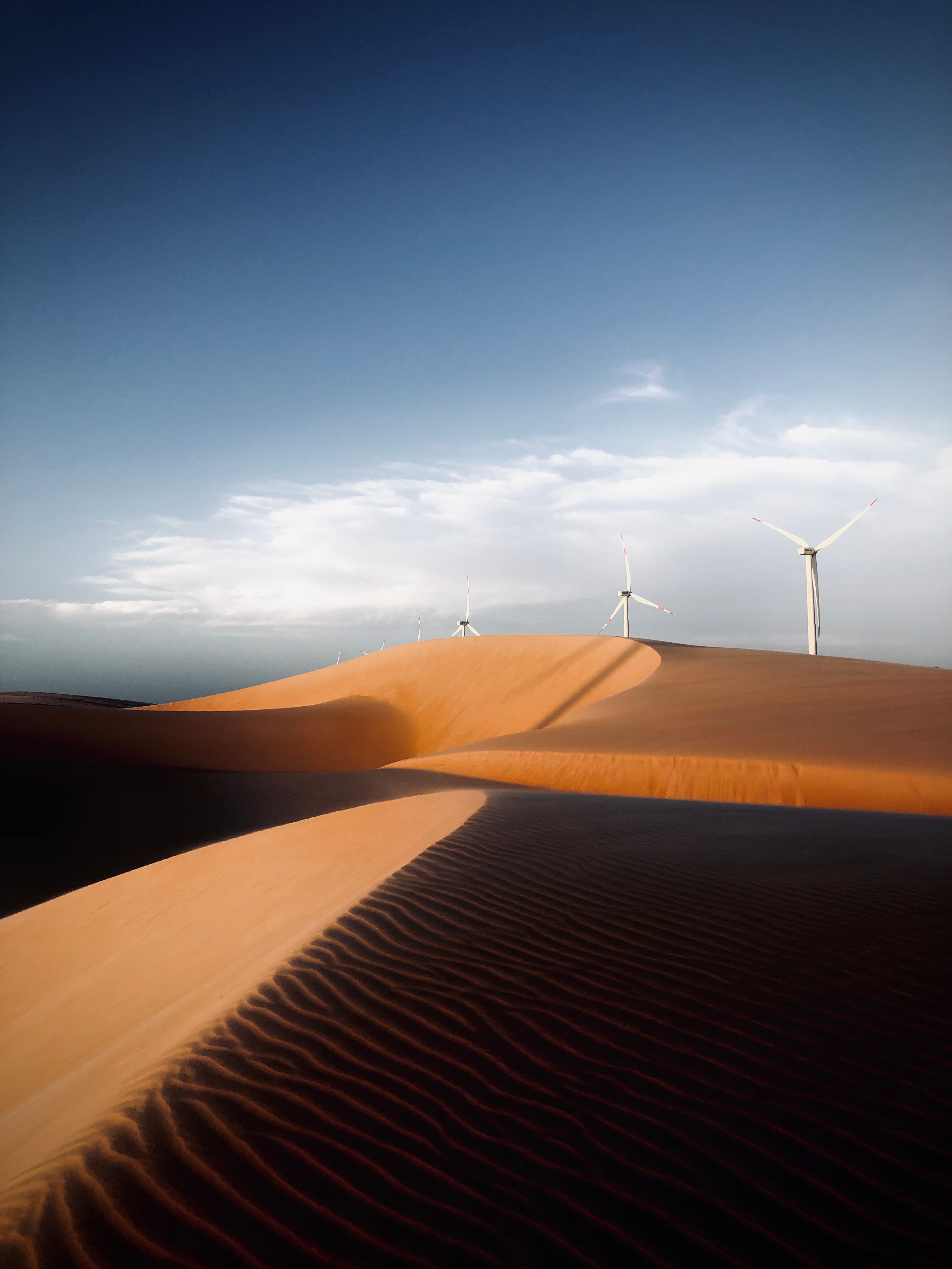 Scenic Desert Wind Turbines Under Blue Sky · Free Stock Photo