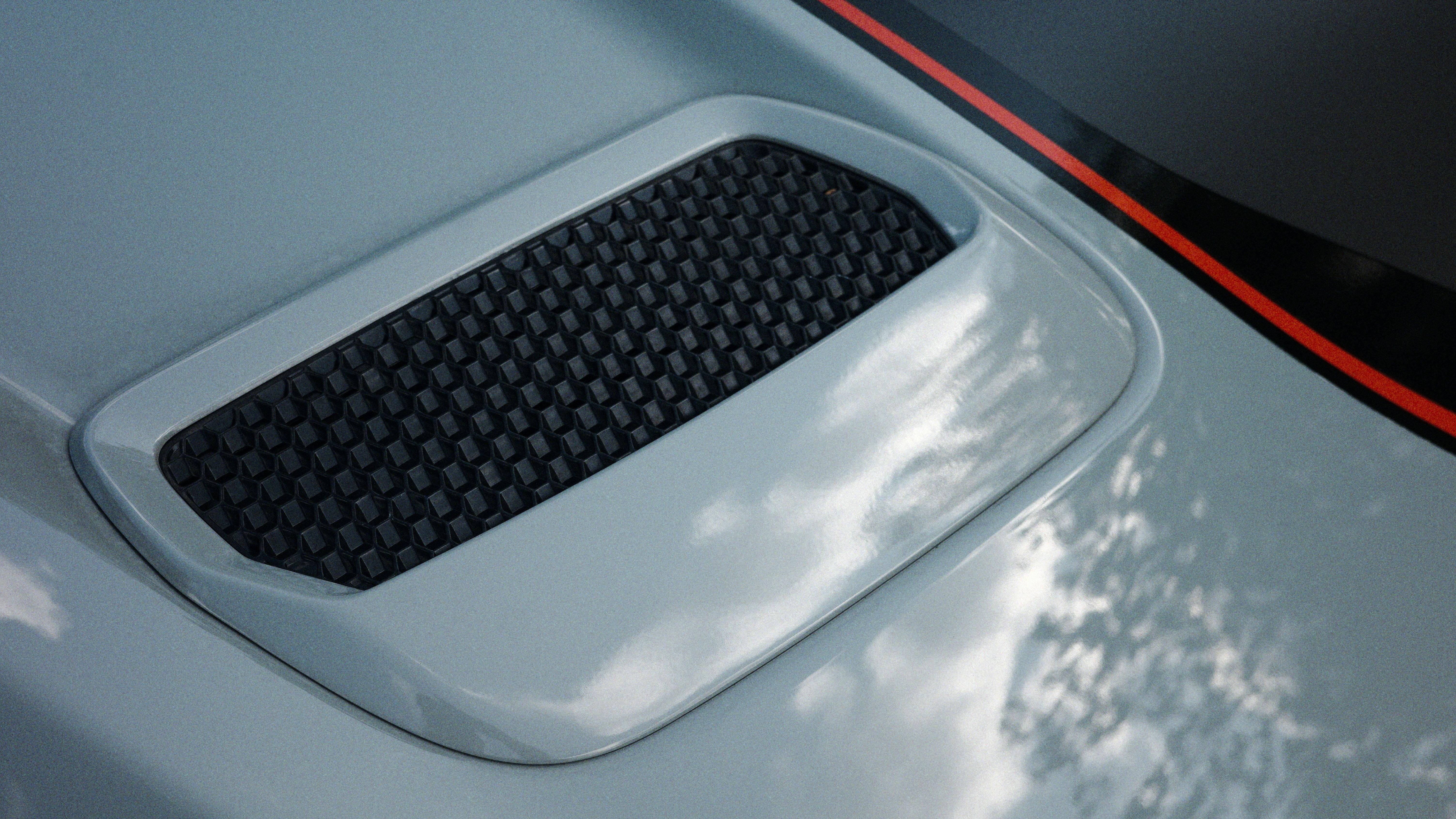 Close-up of a Car Engine Vent with a Red Stripe · Free Stock Photo