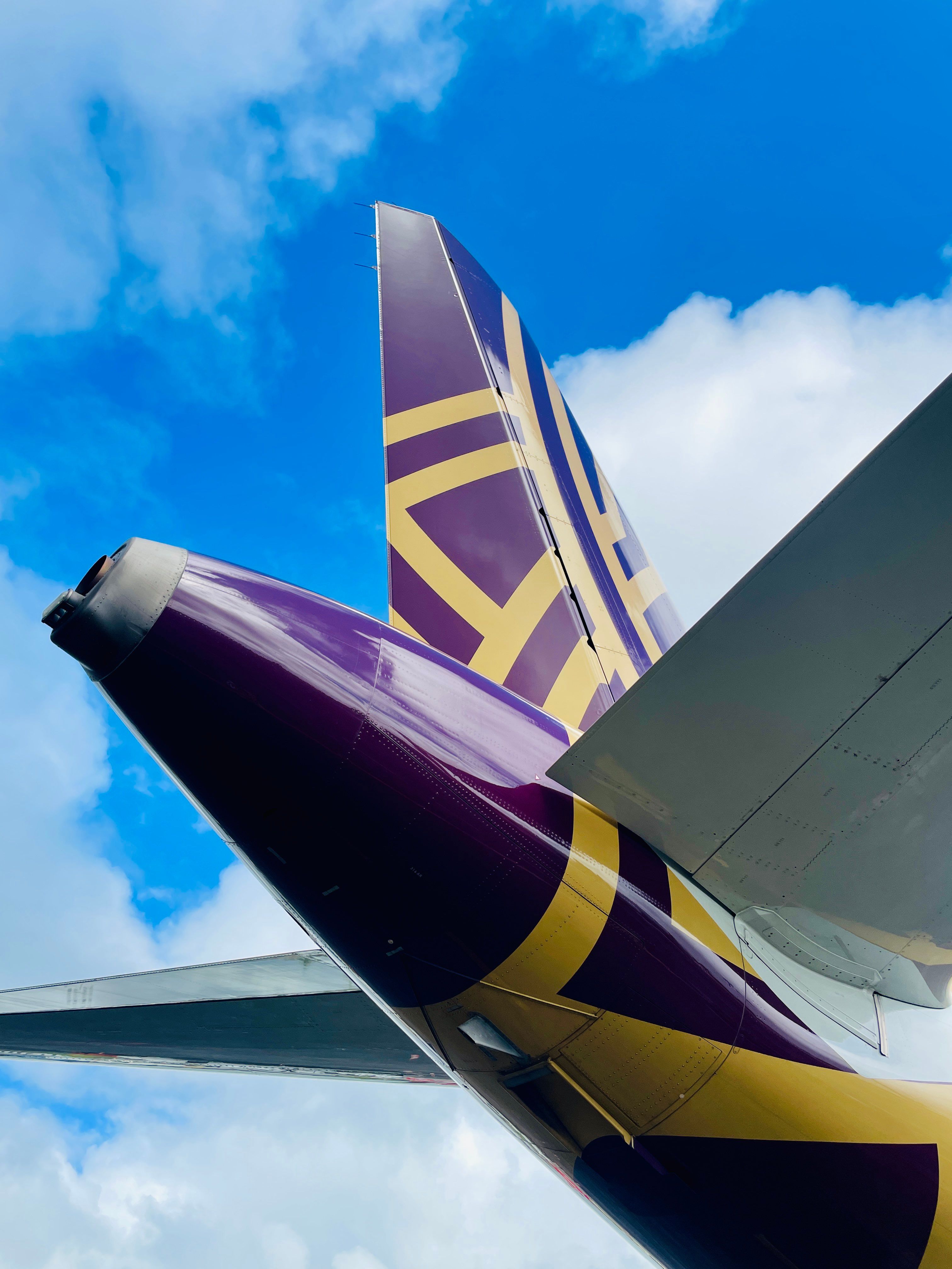Close-up of Airplane Tail Against Blue Sky · Free Stock Photo