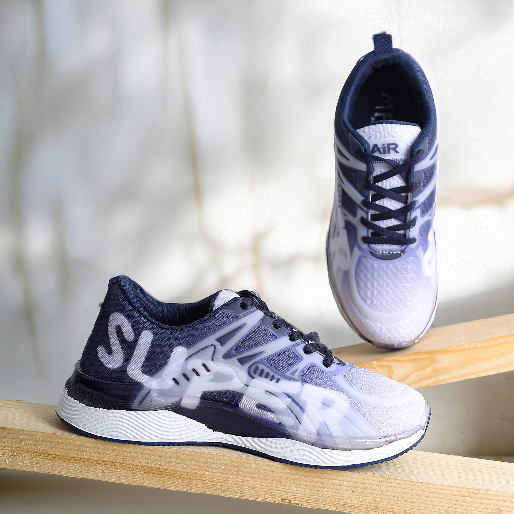 Stylish Sports Shoes on Wooden Plank Display · Free Stock Photo