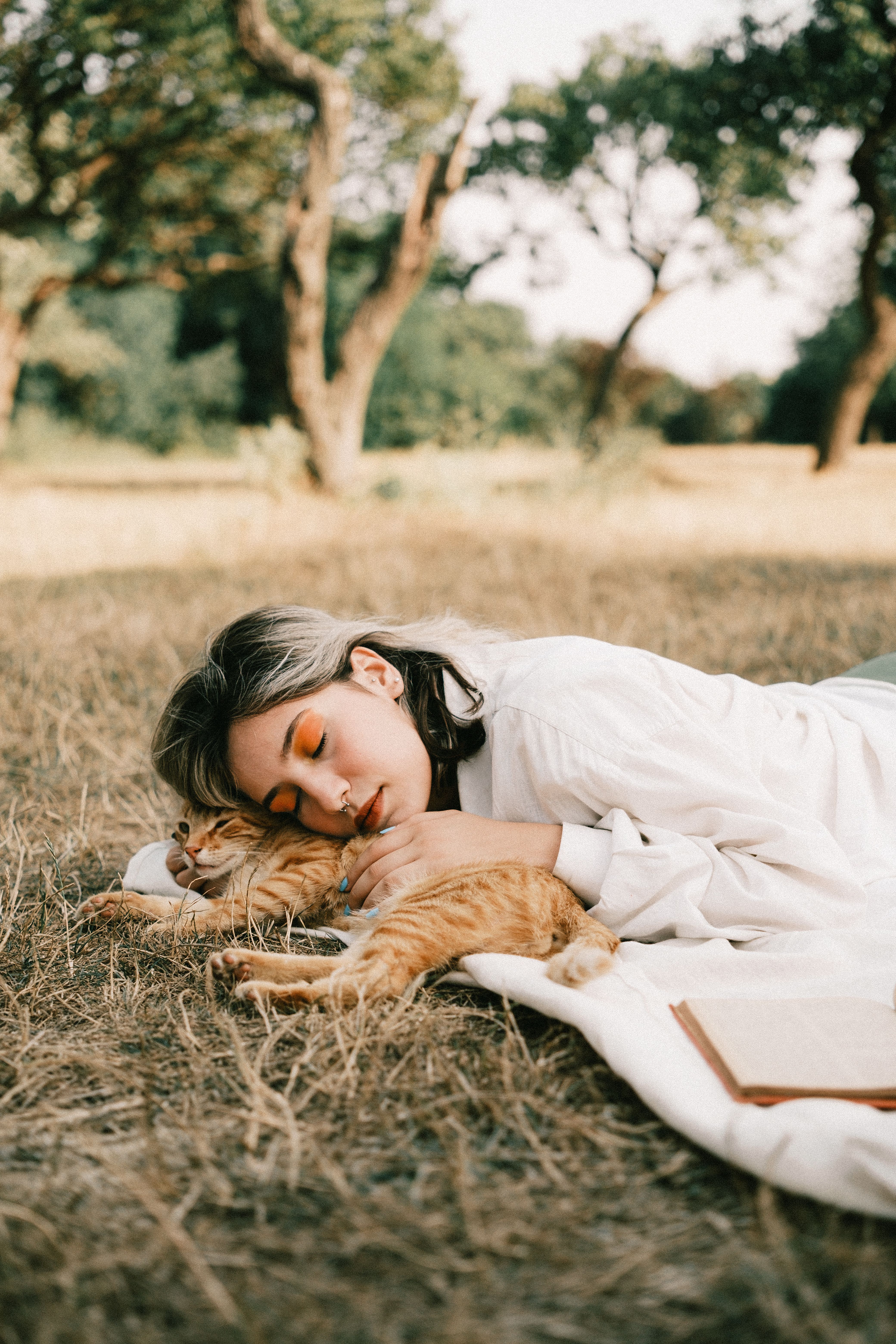 Woman Relaxing Outdoors with Cat on a Blanket · Free Stock Photo